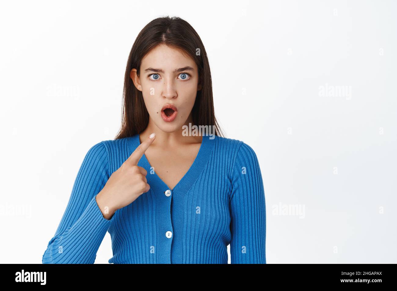 Portrait of caucasian woman pointing at herself with surprised face ...