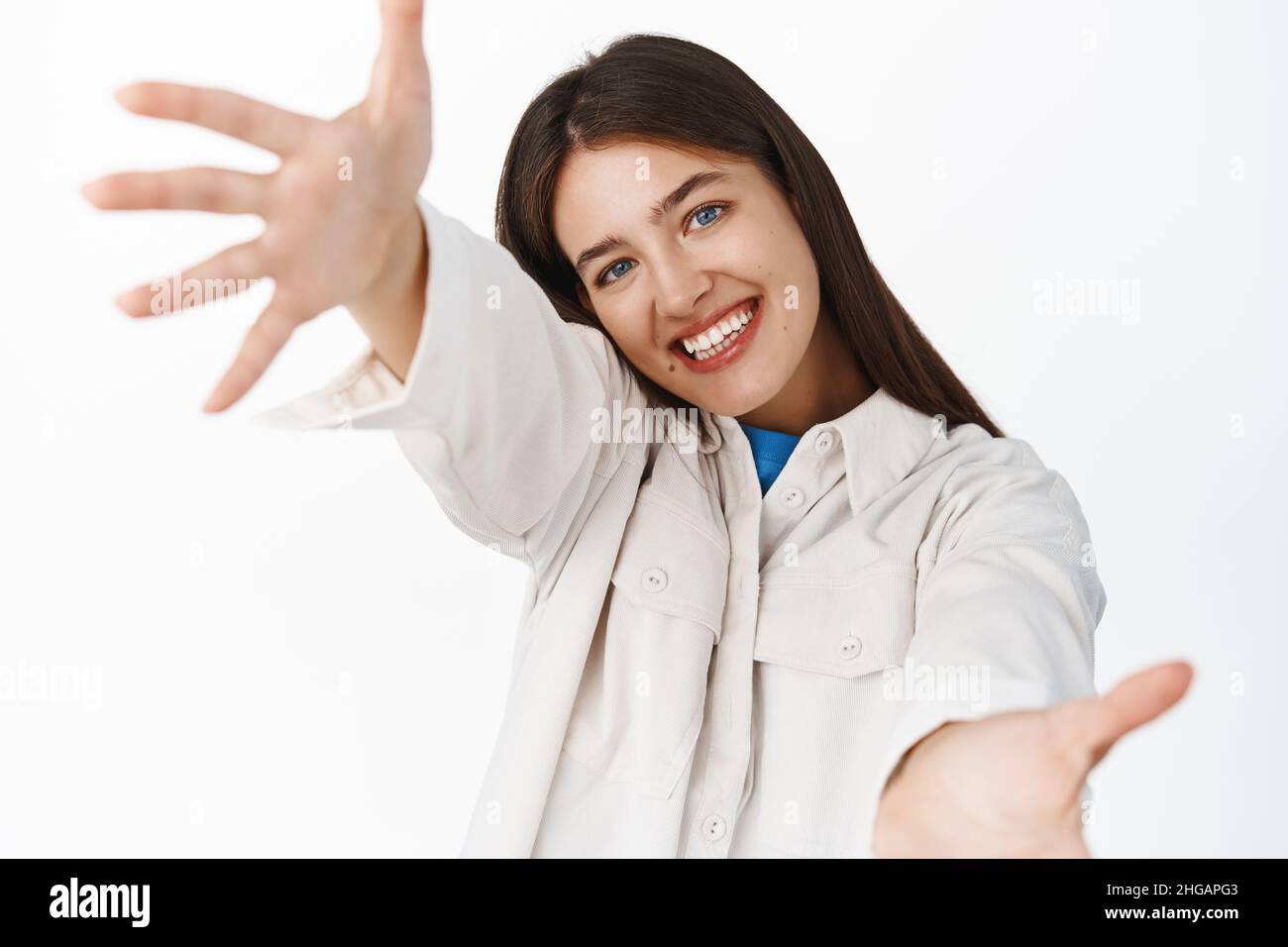 Image of smiling girl stretching out hands, reaching forward, standing ...