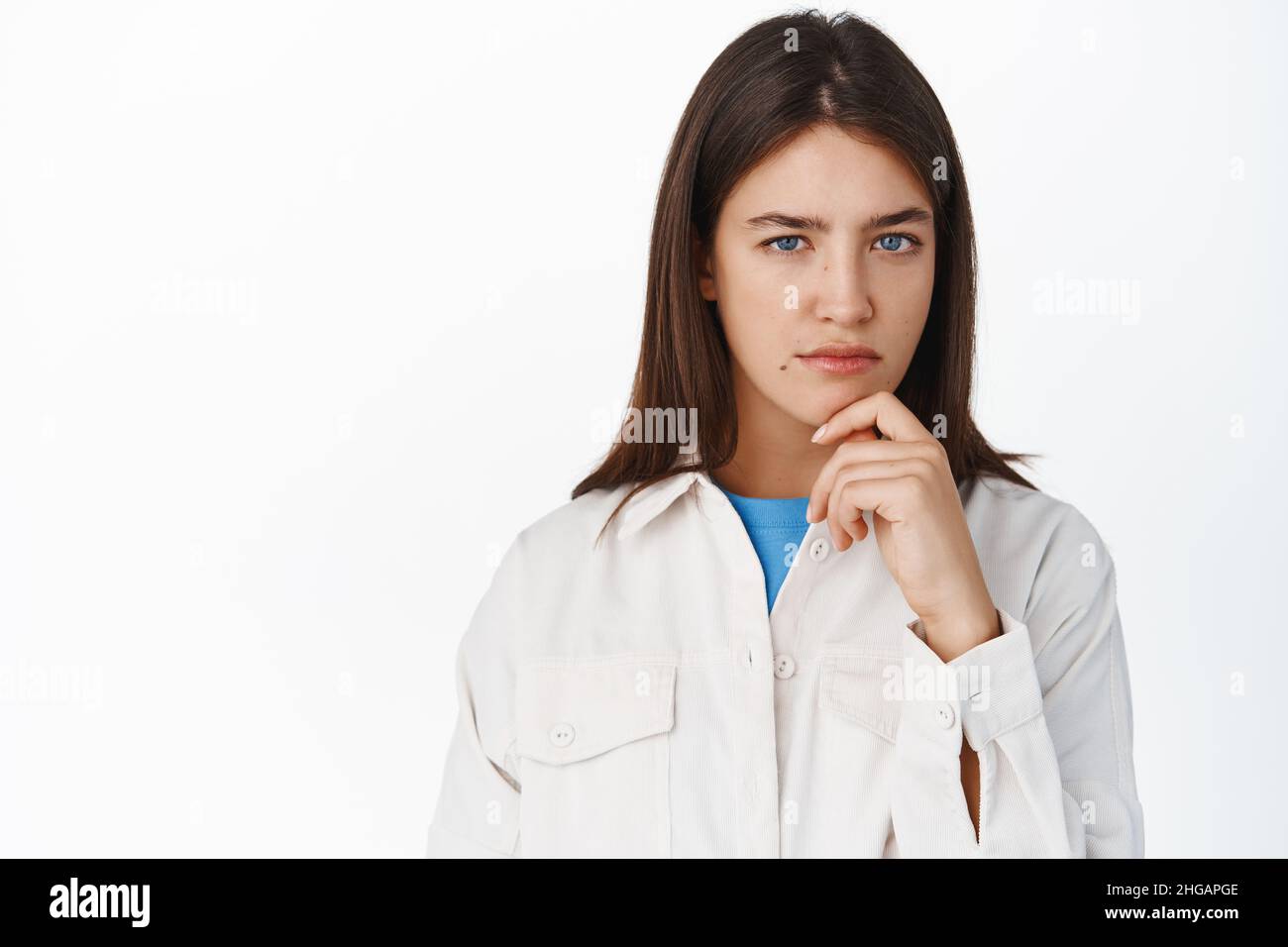 Close up of girl looking with doubtful, thinking face, being hesitant ...