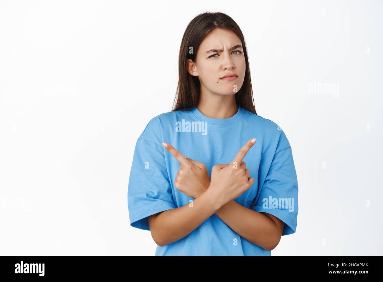 Confused young student girl pointing sideways. showing left and right ...