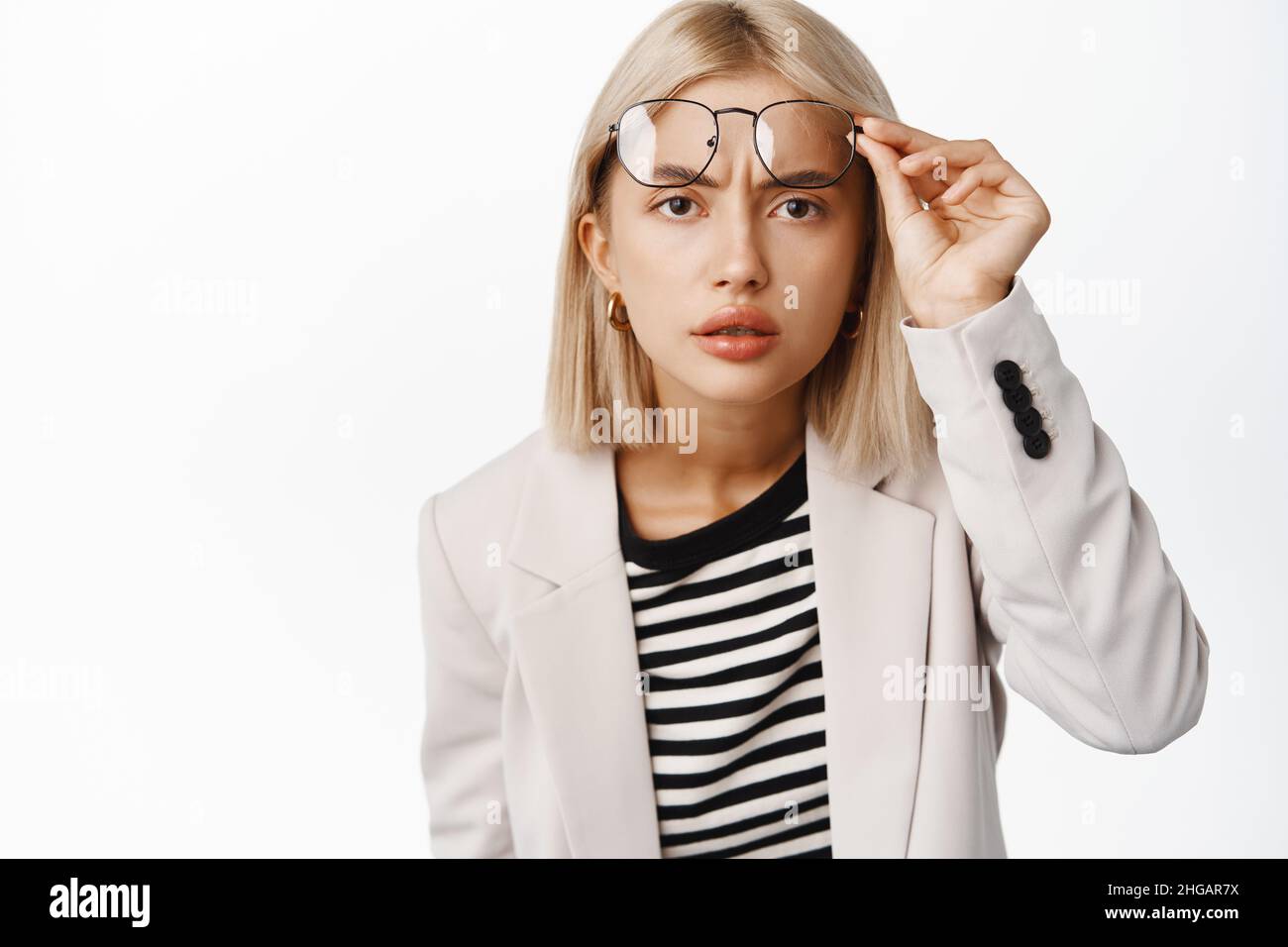 Close up portrait of young woman take off glasses, squinting and ...