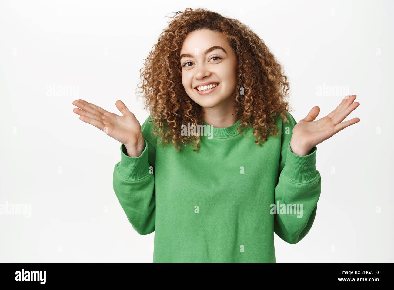 Cute caucasian girl shrugs and looks clueless, puzzled, dont know ...