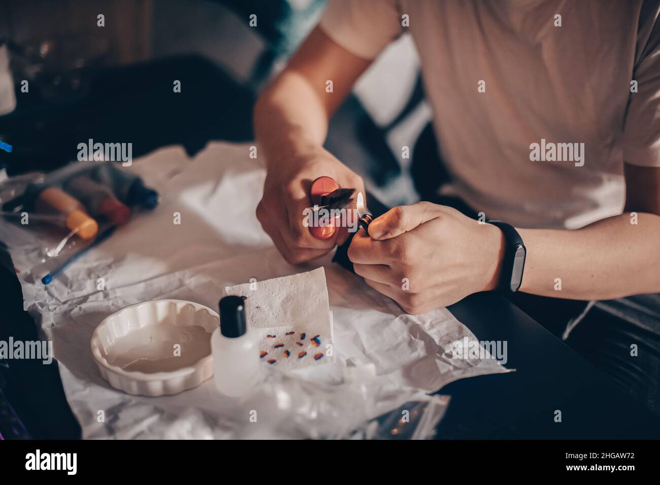 Male hands refill printer cartridge. The guy makes holes in the ...