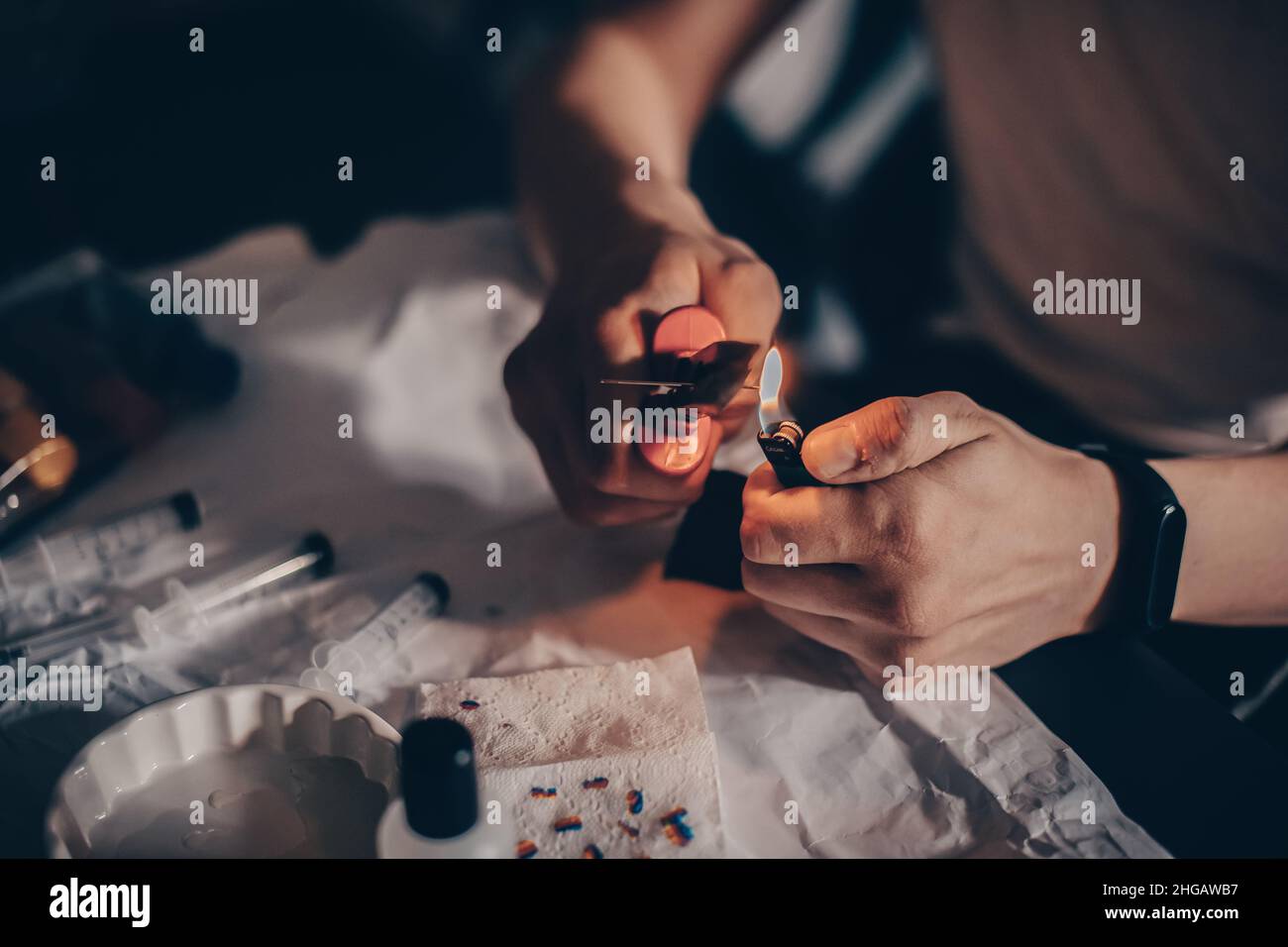 Male hands refill printer cartridge. The guy makes holes in the ...