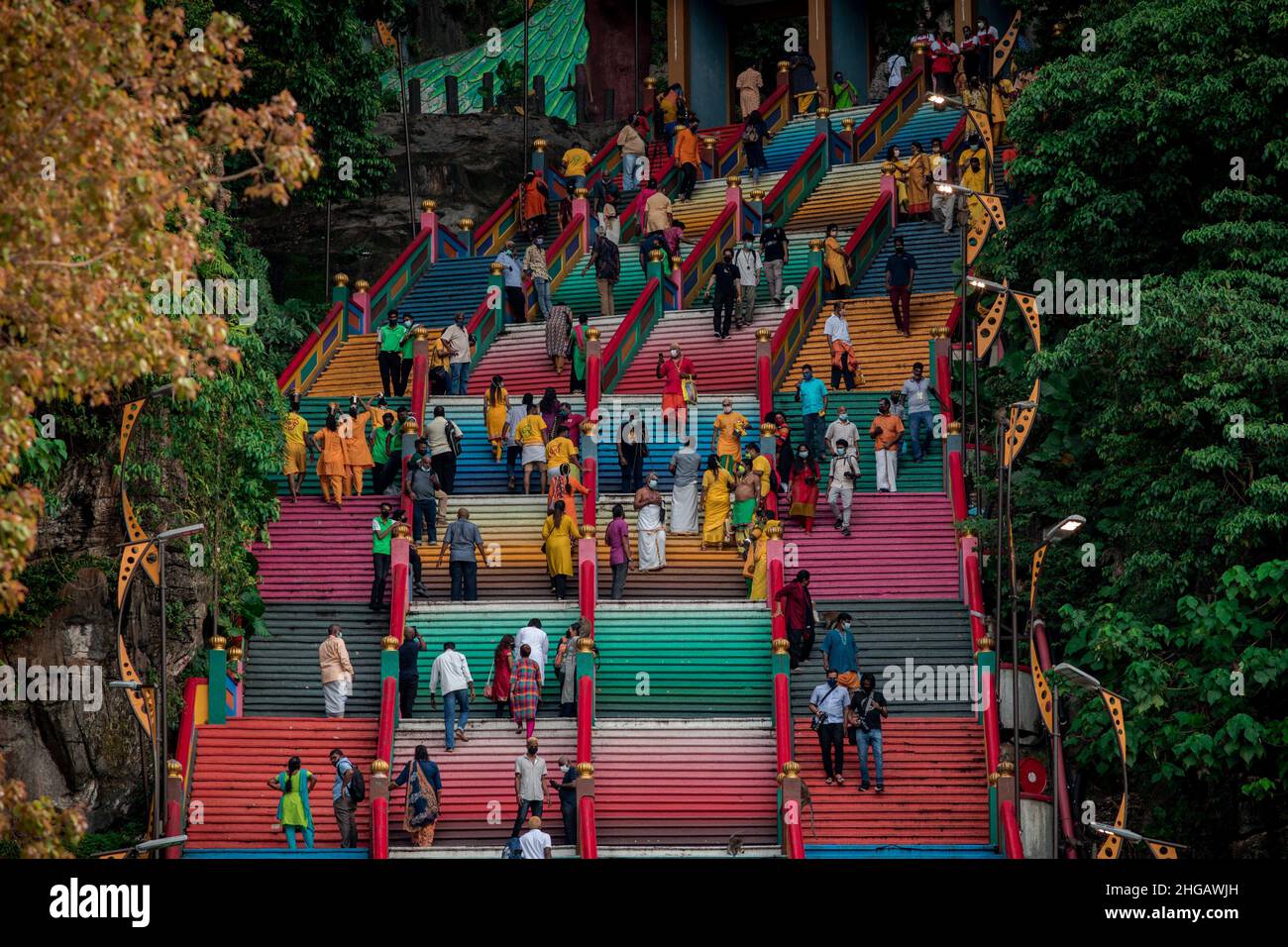 Hindu Devotees wearing face masks are seen performing religious rituals ...