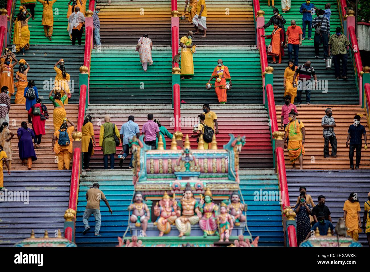 Hindu Devotees wearing face masks are seen performing religious rituals ...