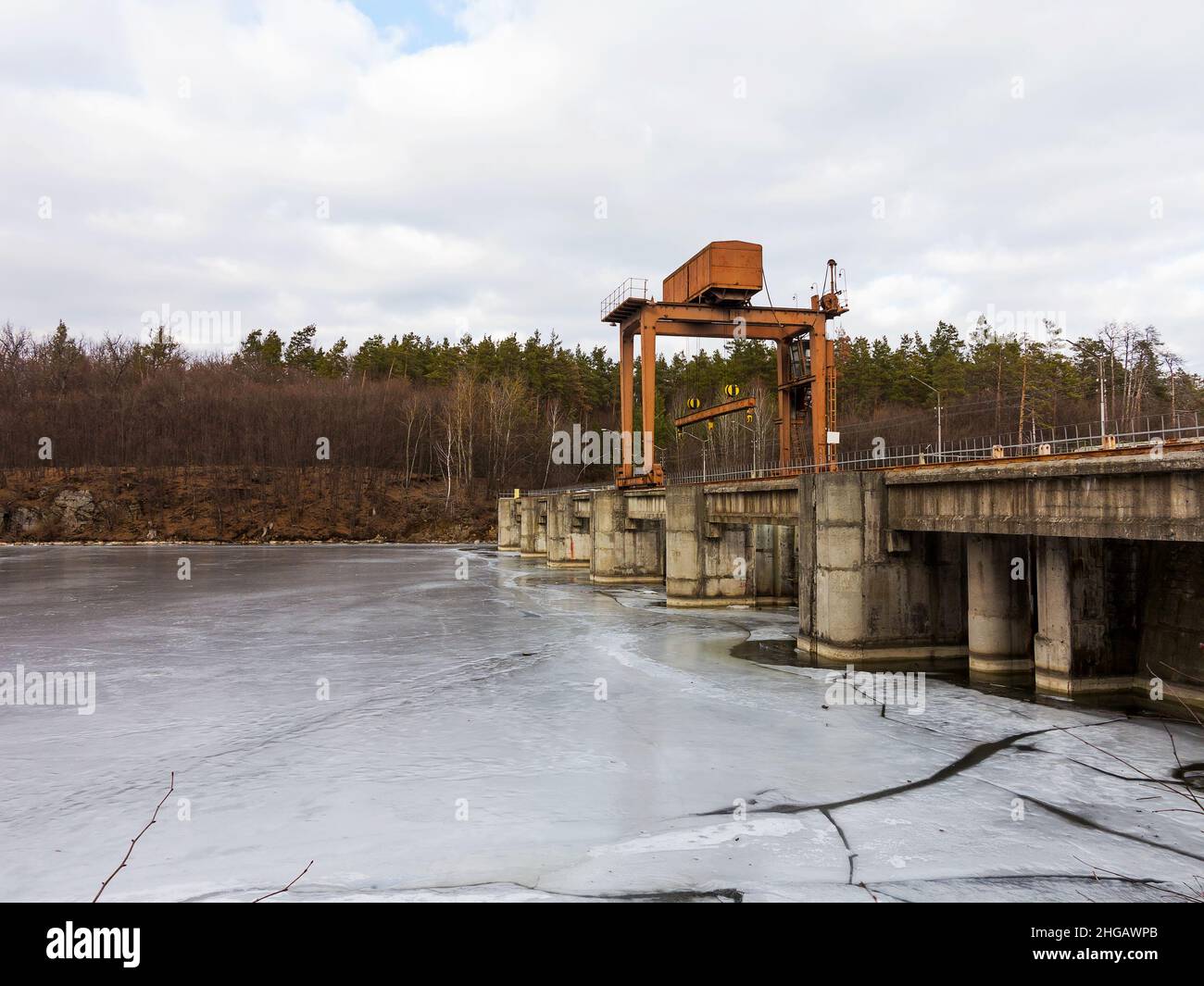 Old crumbling dam across the river, a crossing over the dam road ...