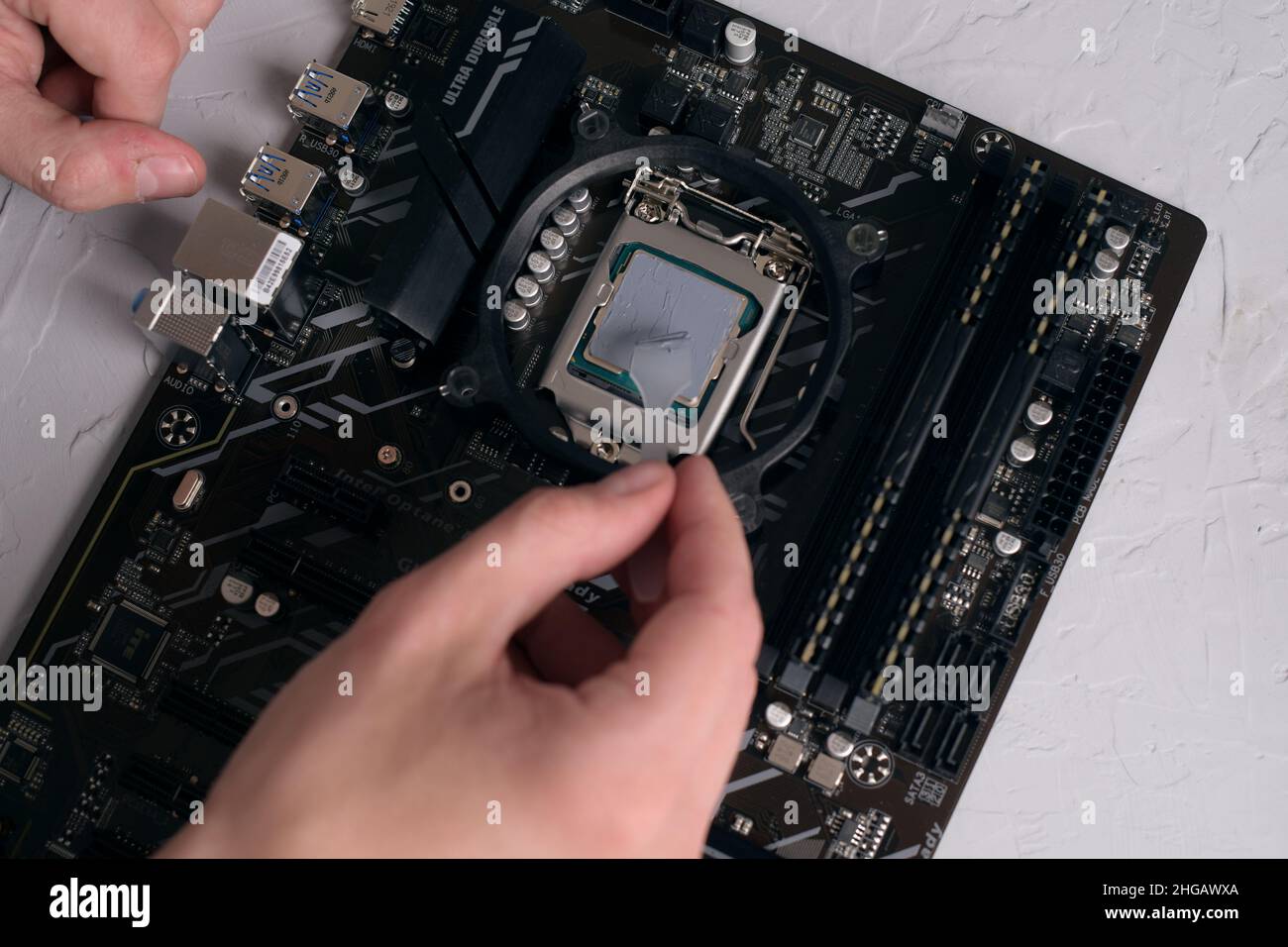 Engineer plugging CPU microprocessor to motherboard socket. Computer technology hardware ...