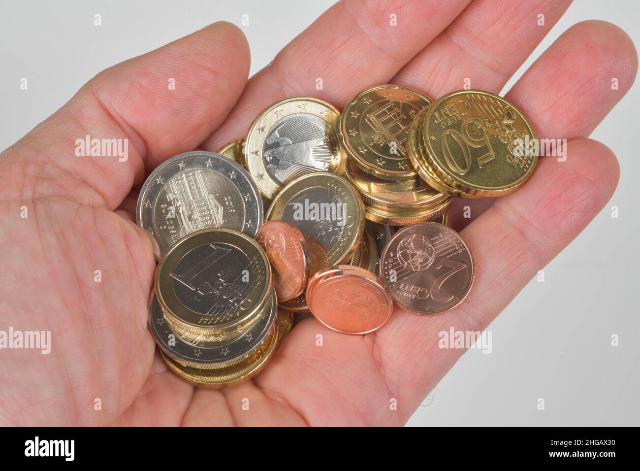 Hand, euro coins, cent coins, symbol photo, studio shot Stock Photo - Alamy