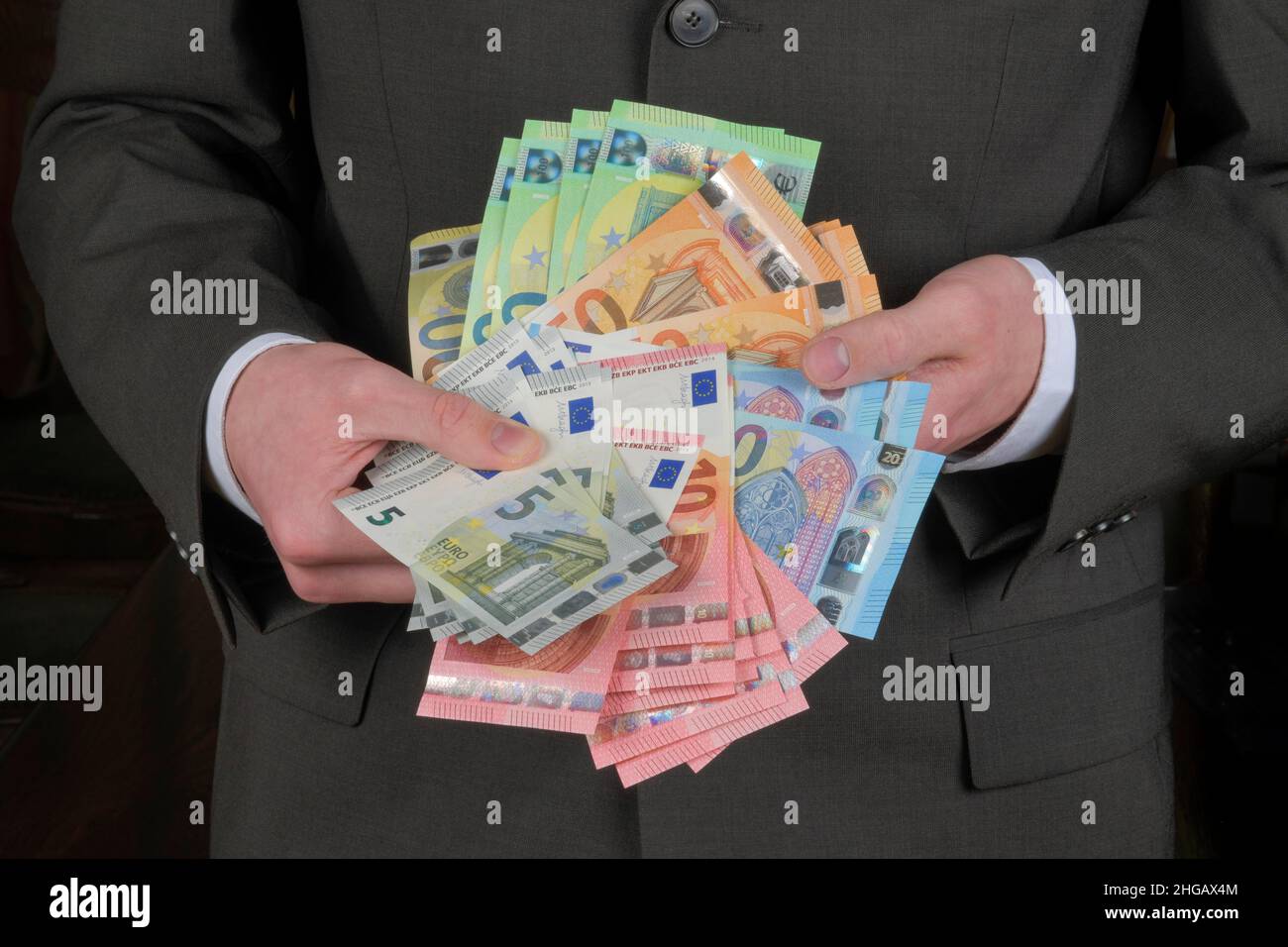 Hand, euro notes, symbol photo bribery, studio shot Stock Photo - Alamy