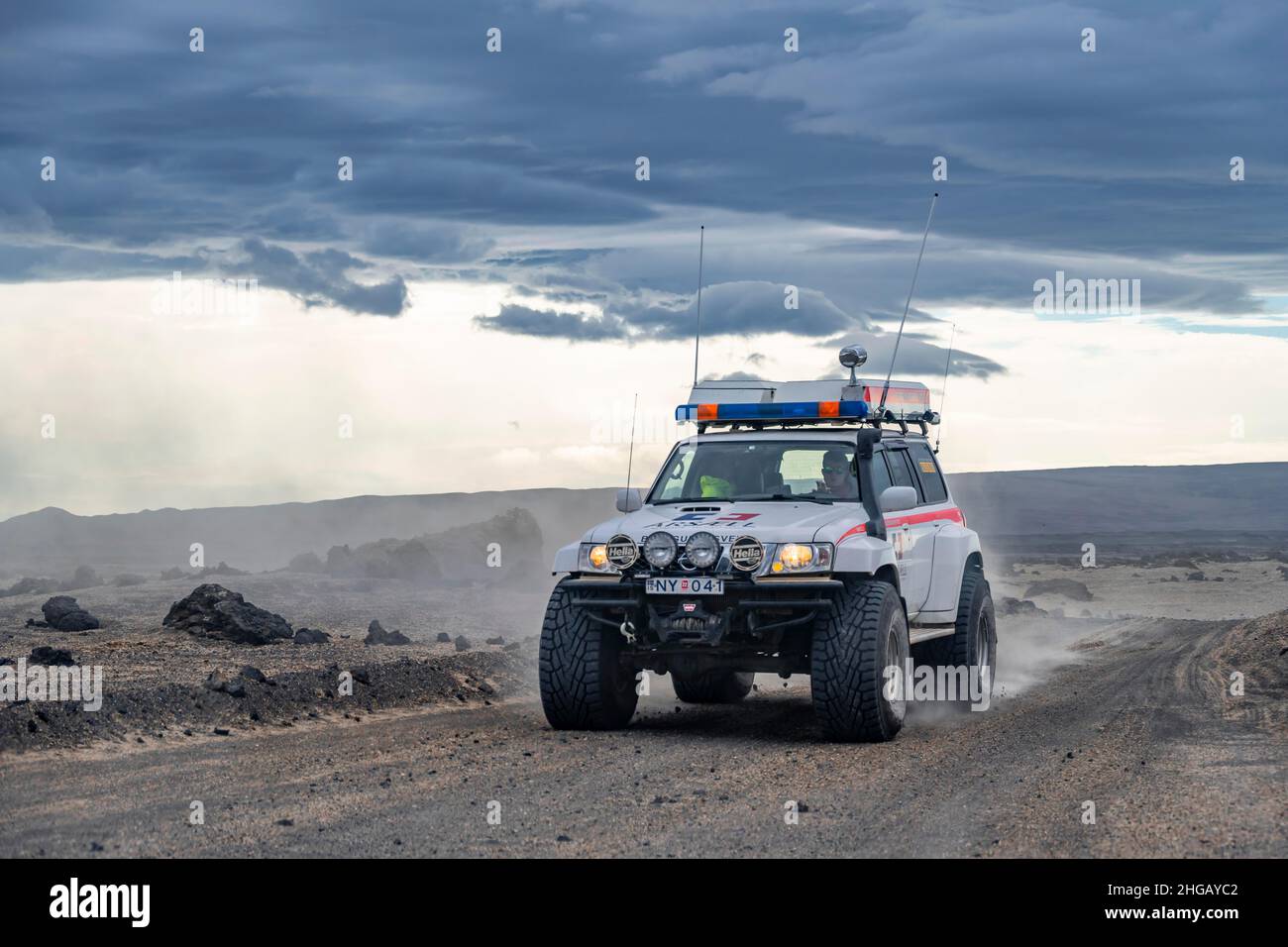 Icelandic Road Rescue 4x4 car on gravel road, barren landscape ...