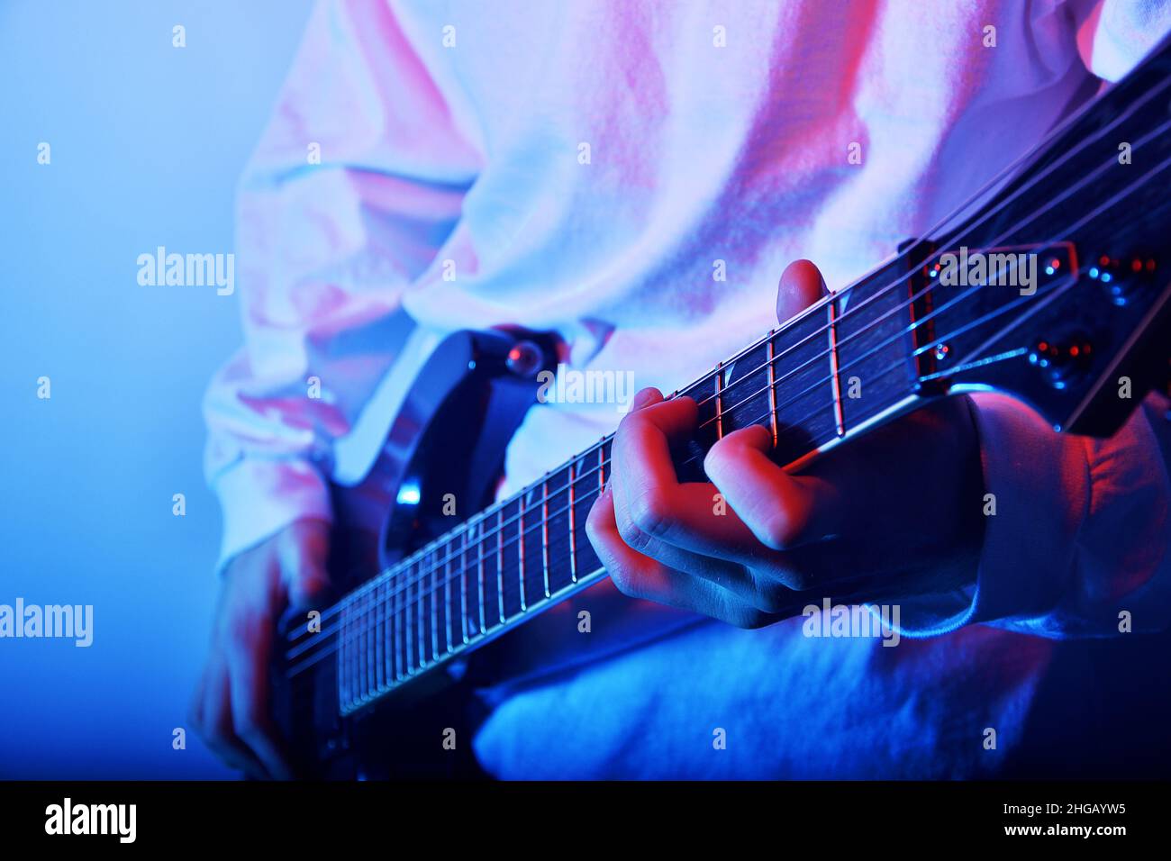 Portrait of young man artist singing, screaming, playing electric ...