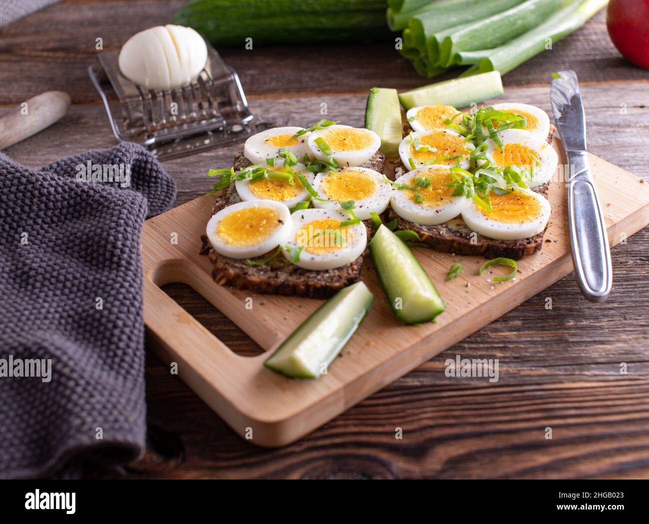 Boiled egg sandwich made with whole grain bread, butter and chives on ...