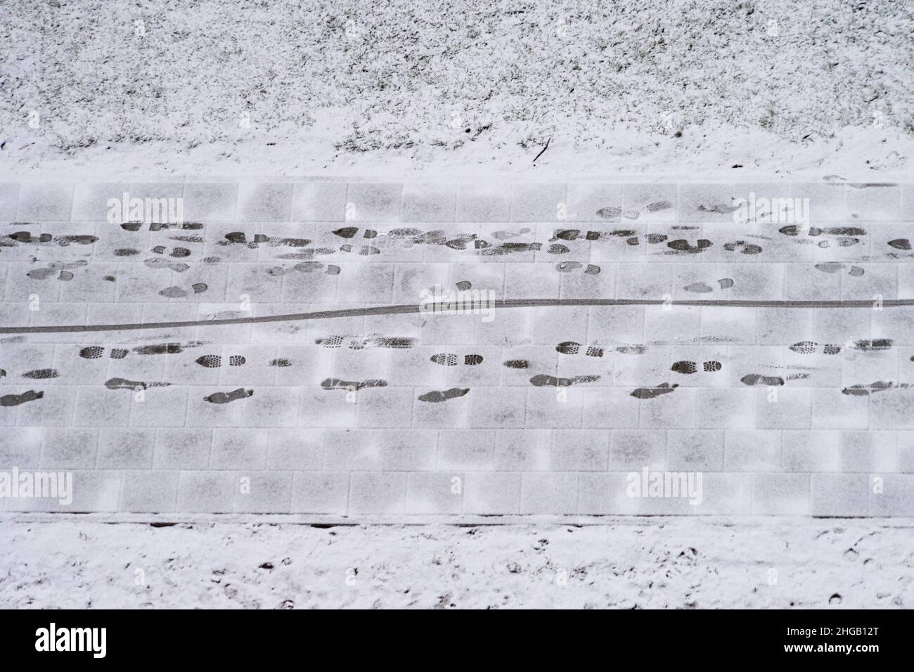 Maintenance of streets and sidewalks in winter. Light snowy sidewalk ...