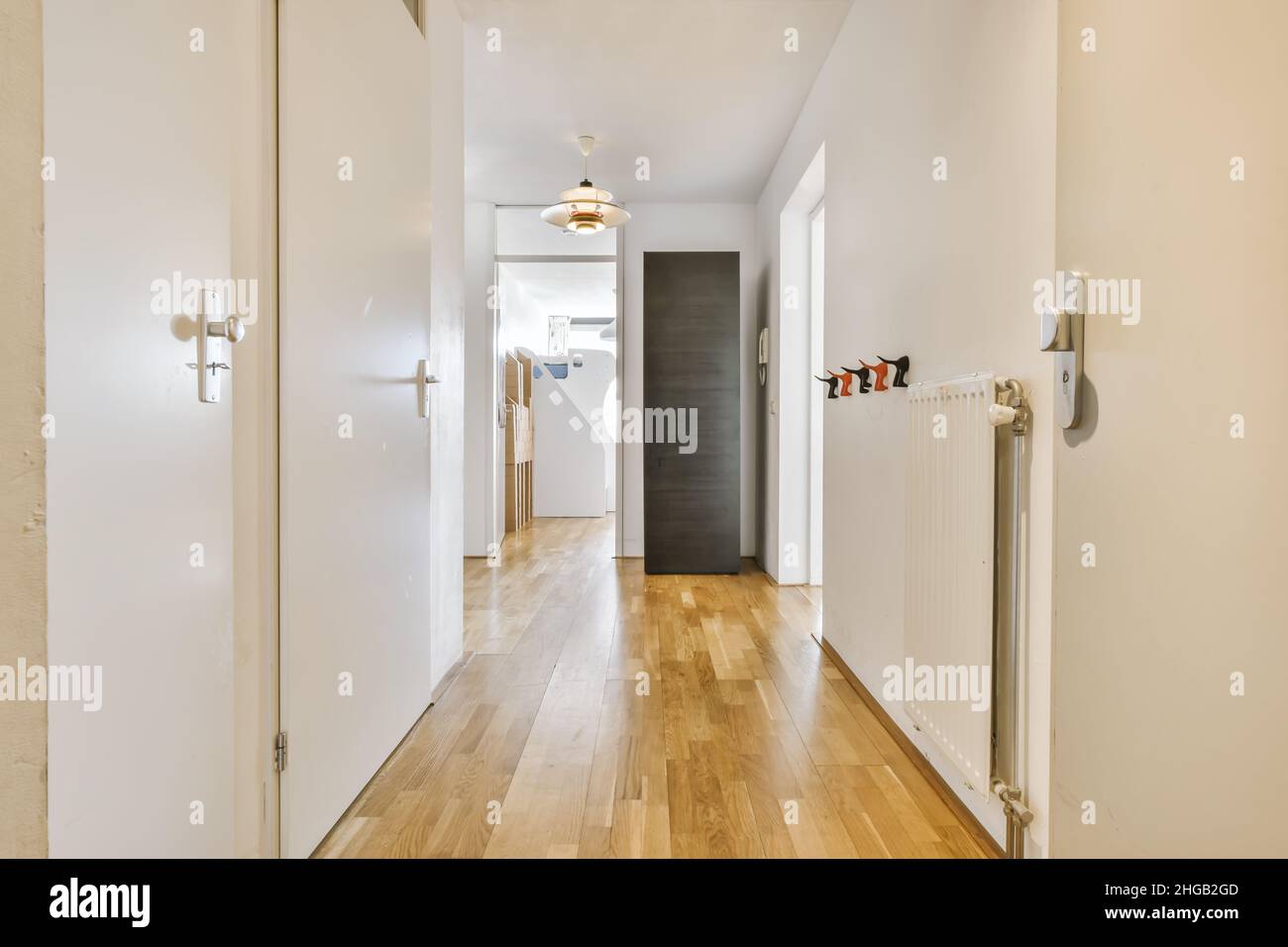 Cozy corridor with white walls and wooden floor Stock Photo - Alamy