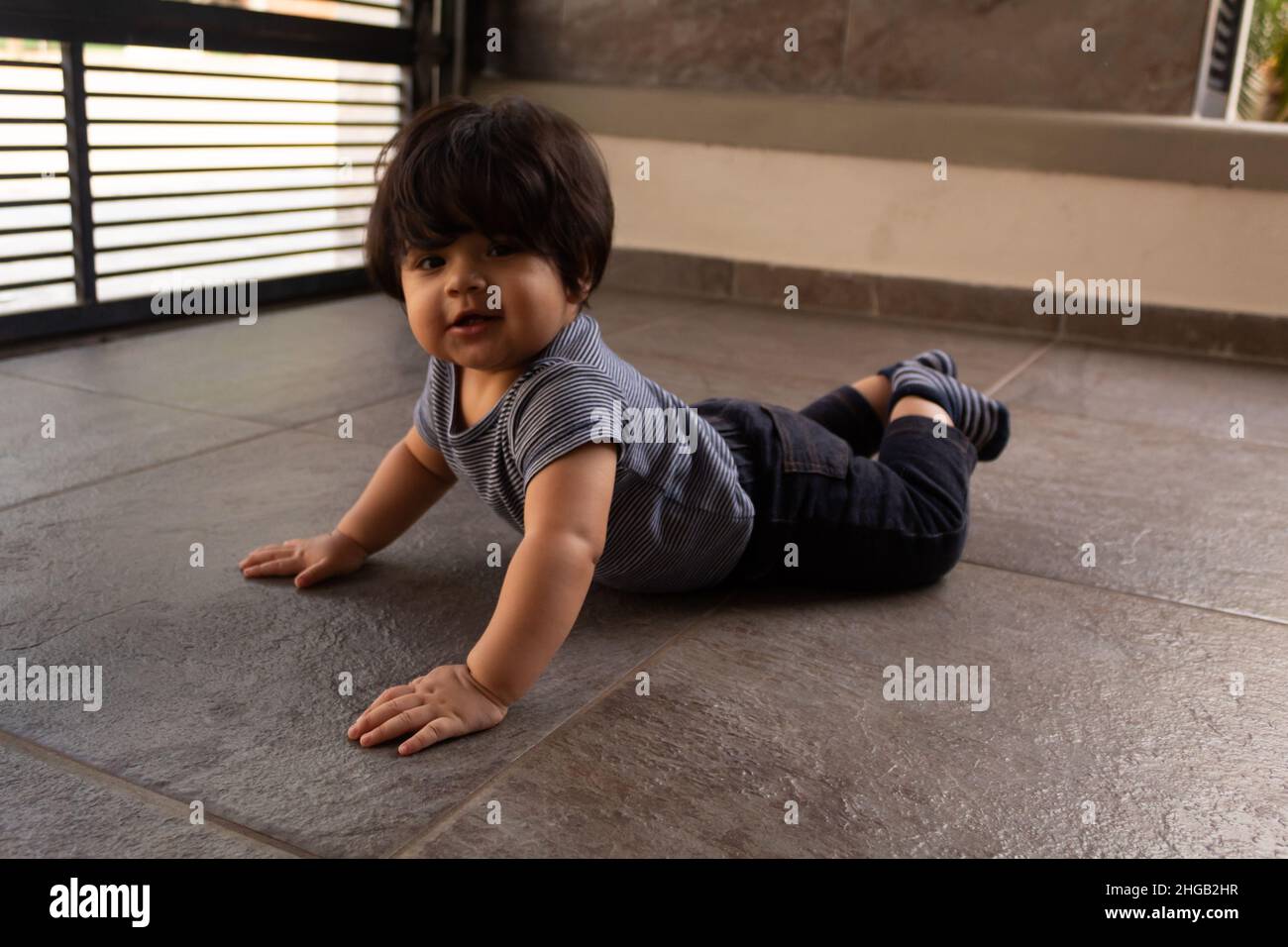 portrait of a beautiful smiling hispanic baby crawling Stock Photo - Alamy