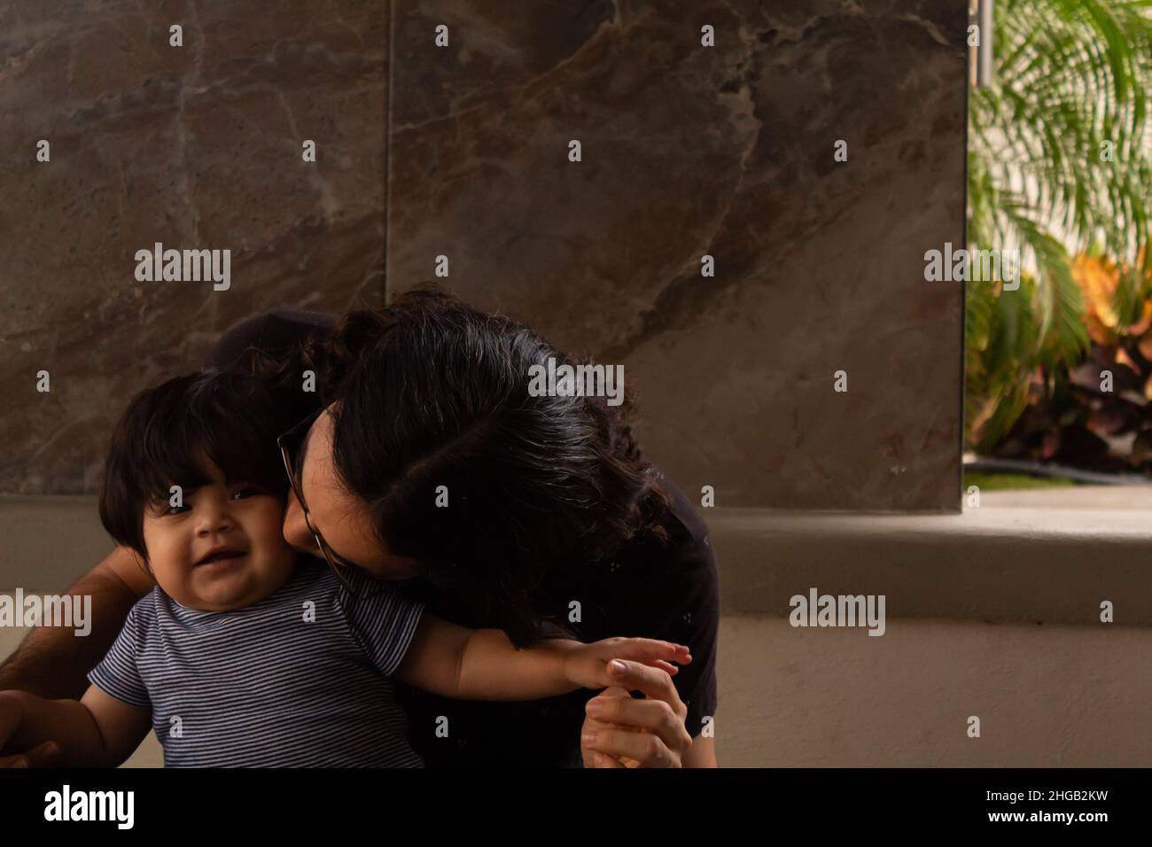 portrait of a young hispanic dad and his baby playing Stock Photo - Alamy