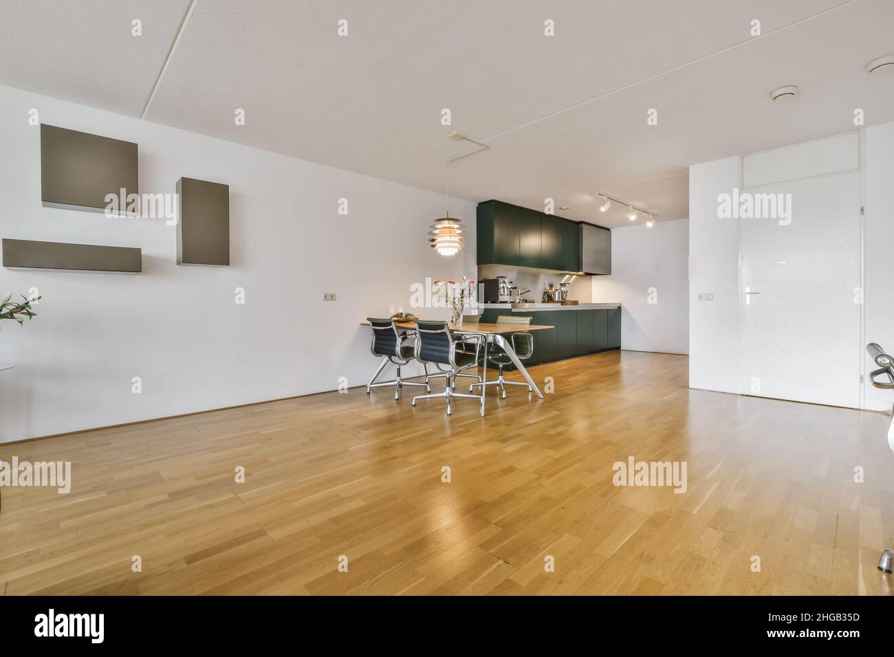 Cozy huge room with a small dining area with stylish table and chairs ...