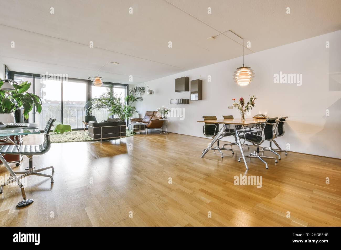 Cozy huge room with a small dining area with stylish table and chairs ...