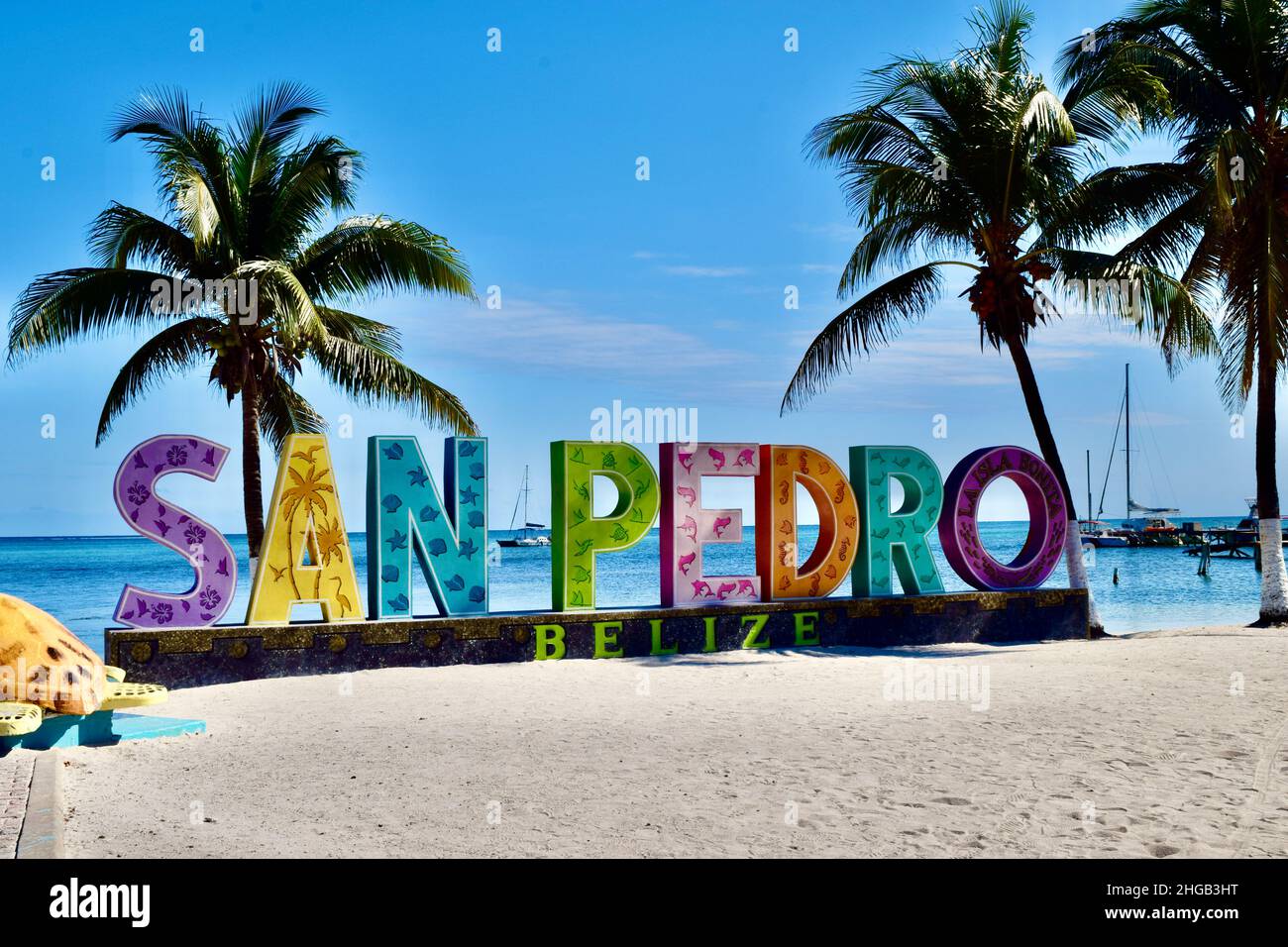 The "San Pedro"sign in central park/town square with the Caribbean Sea ...
