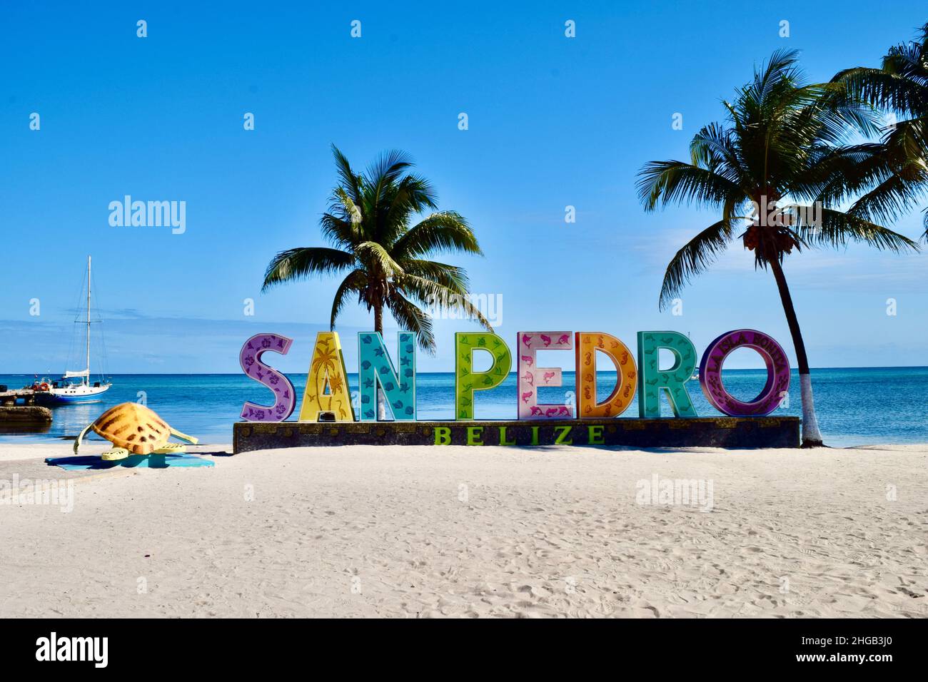 The "San Pedro"sign in central park/town square with the Caribbean Sea ...