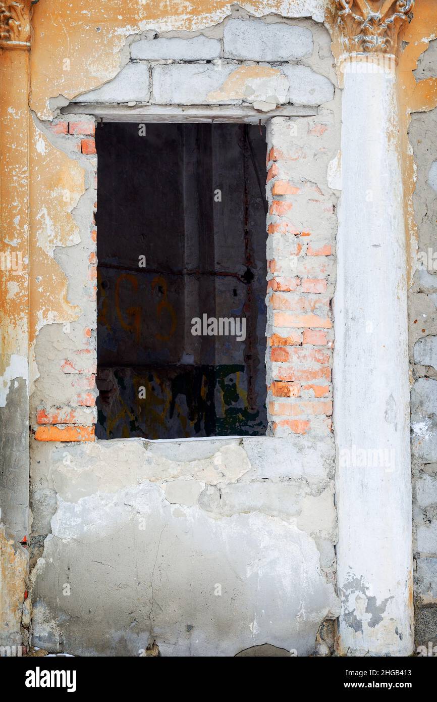 Old building falling apart with broken windows, walls covered with ...