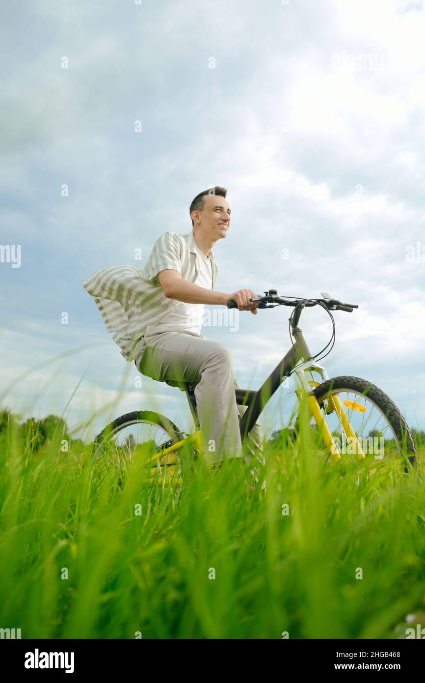 The man is riding a mountain bike. A fashionable guy came to nature in ...