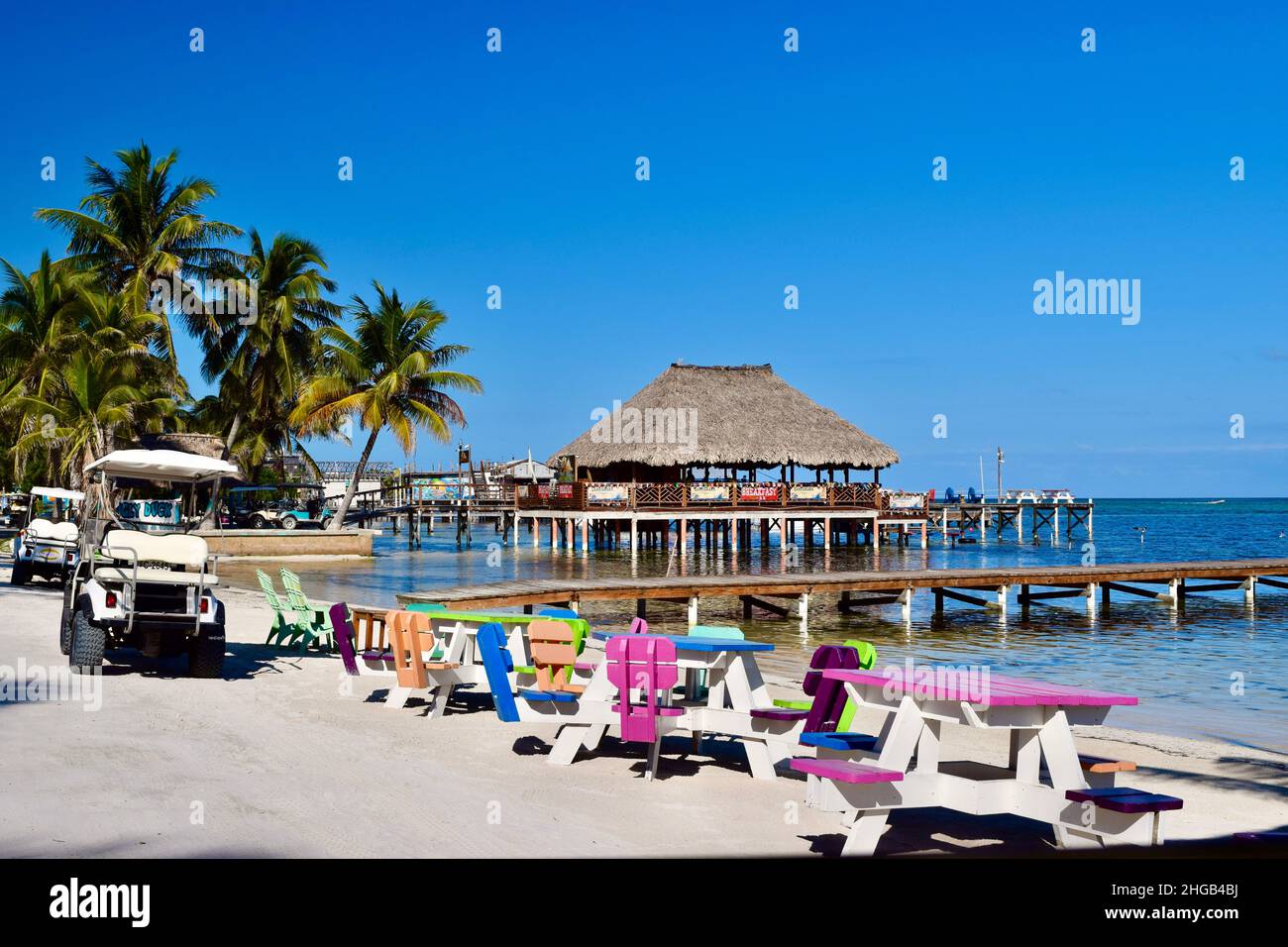 A perfect day at the beach with colorful beach tables, golf carts ...