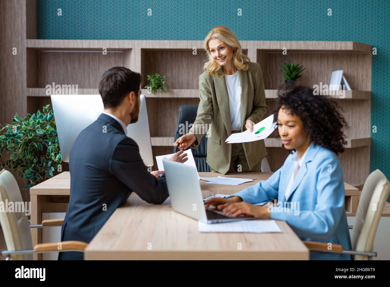 Multiracial group of businesspeople with elegant dress sitting at ...