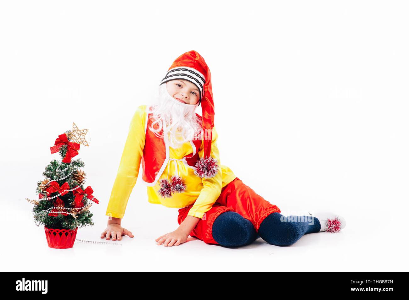 A baby dressed as a elf. isolated. Santa's helper. boy in suit of dwarf ...
