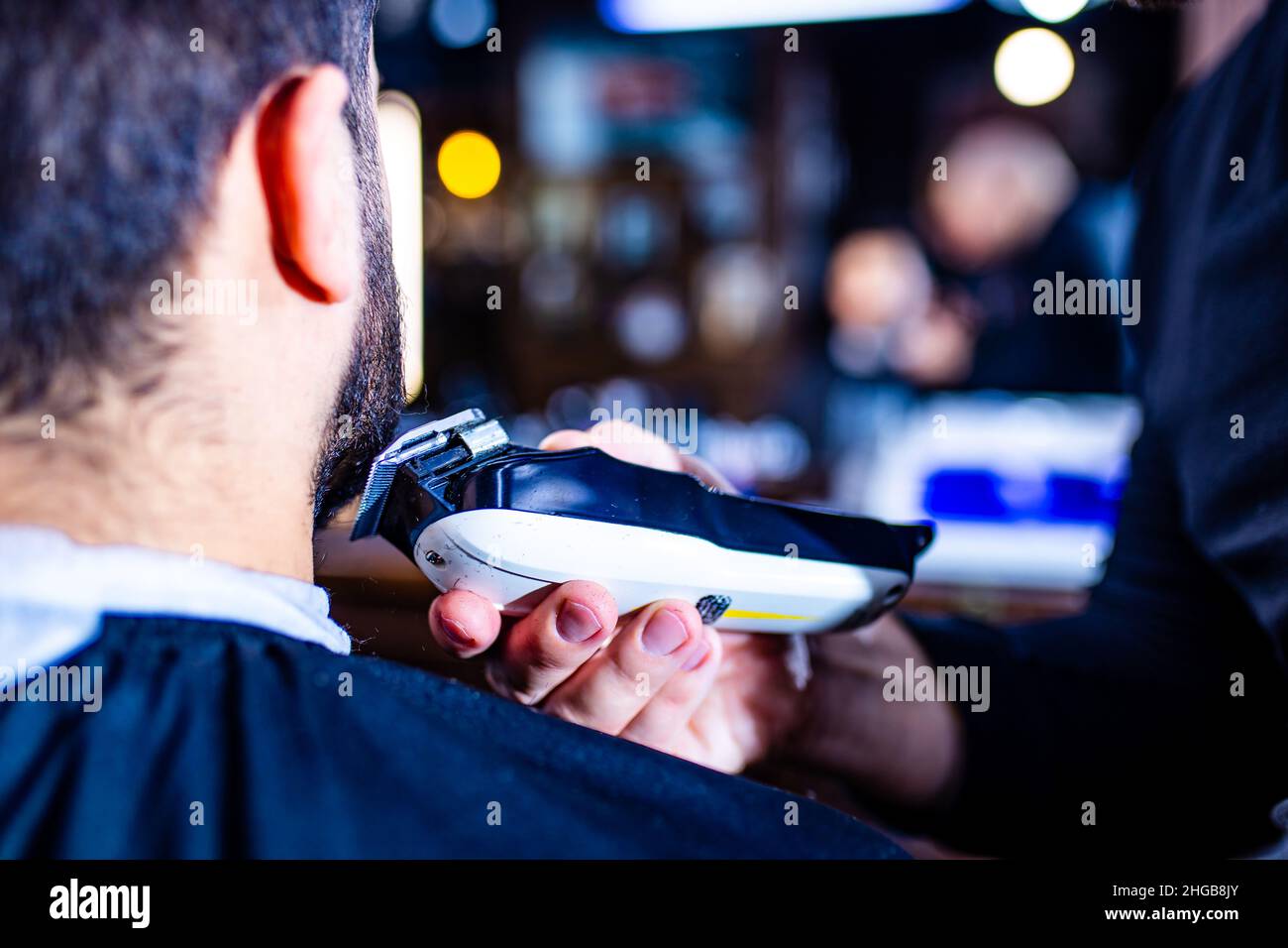 Hairstylist cutting hair of male customer at barber shop Stock Photo ... Hairstylist cutting hair of male customer at barber shop Stock Photo ...