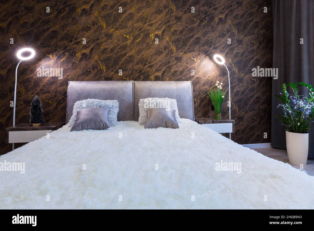 Interior of a modern bedroom with a large bed Stock Photo - Alamy