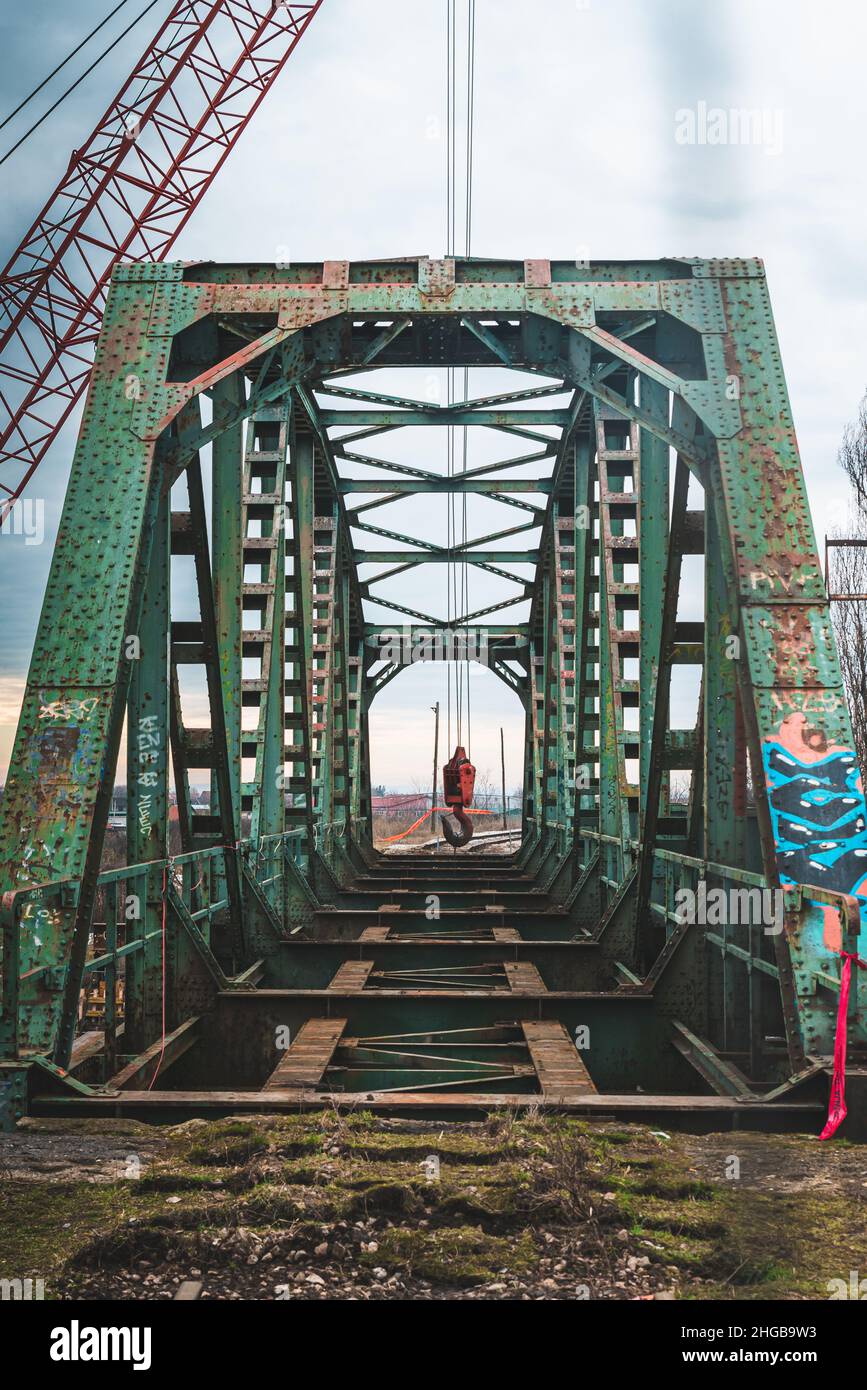Disassembly and cutting of the old steel railway bridge and rusty rails ...