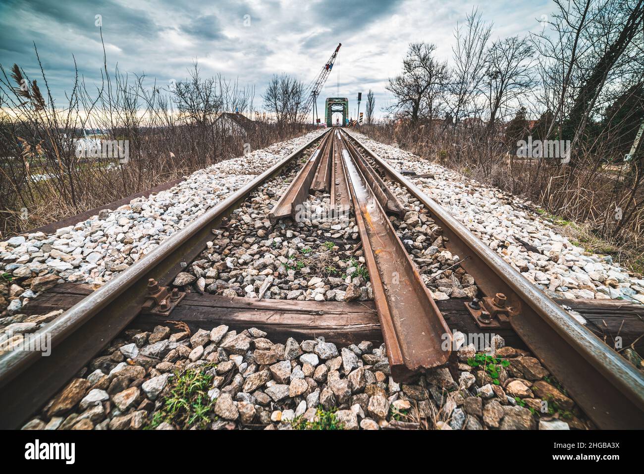 Disassembly and cutting of the old steel railway bridge and rusty rails ...