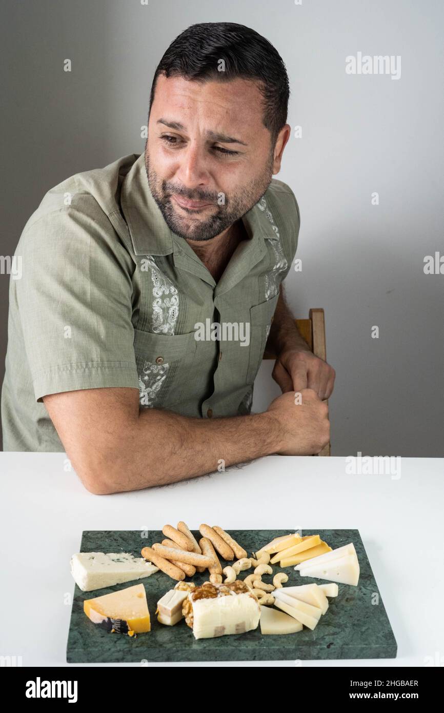 Man enjoying a French cheese board Stock Photo - Alamy