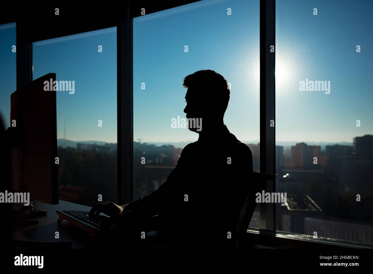 Successful businessman boss working at computer on the background of ...