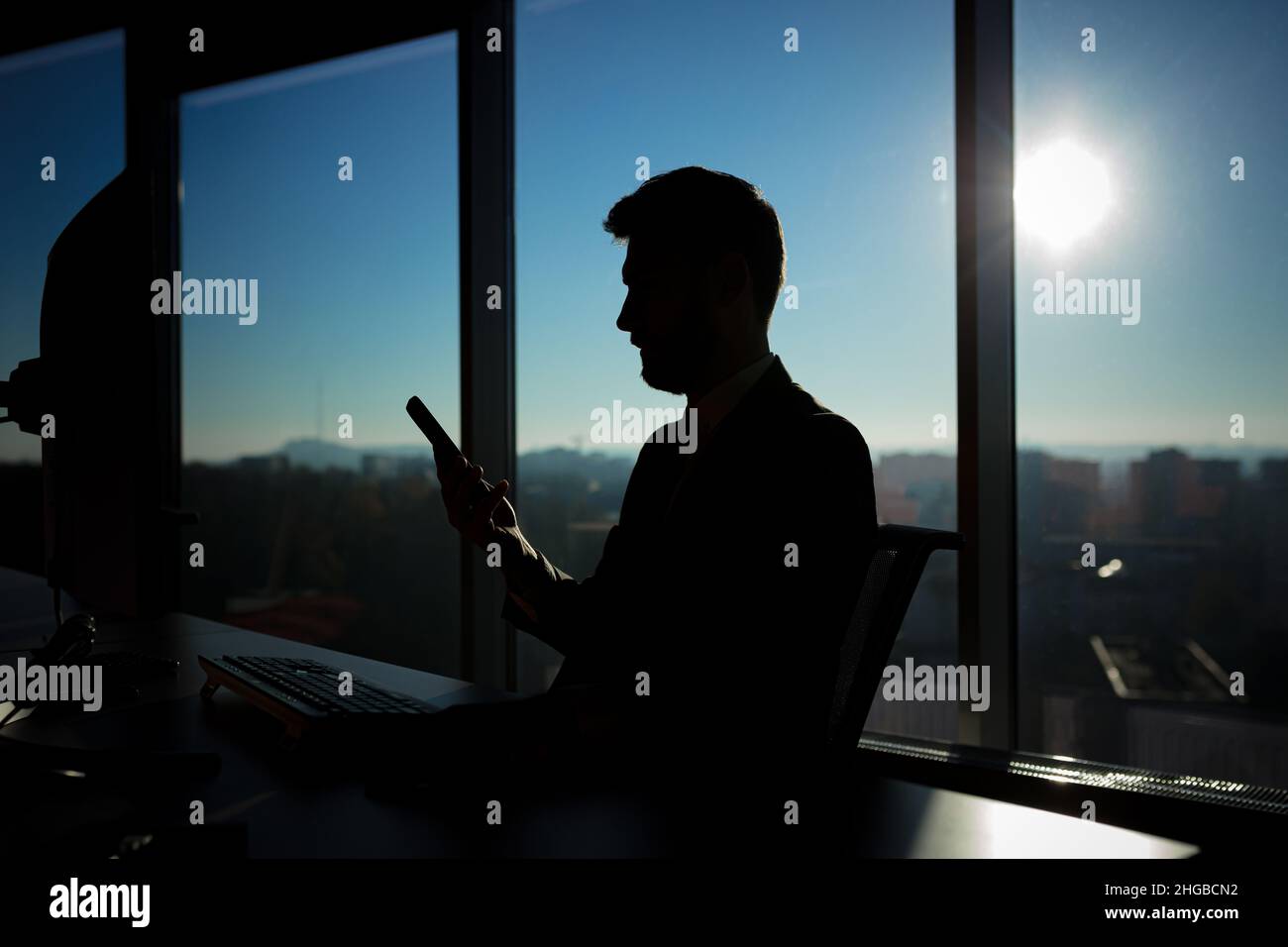 Successful businessman boss working at computer on the background of ...