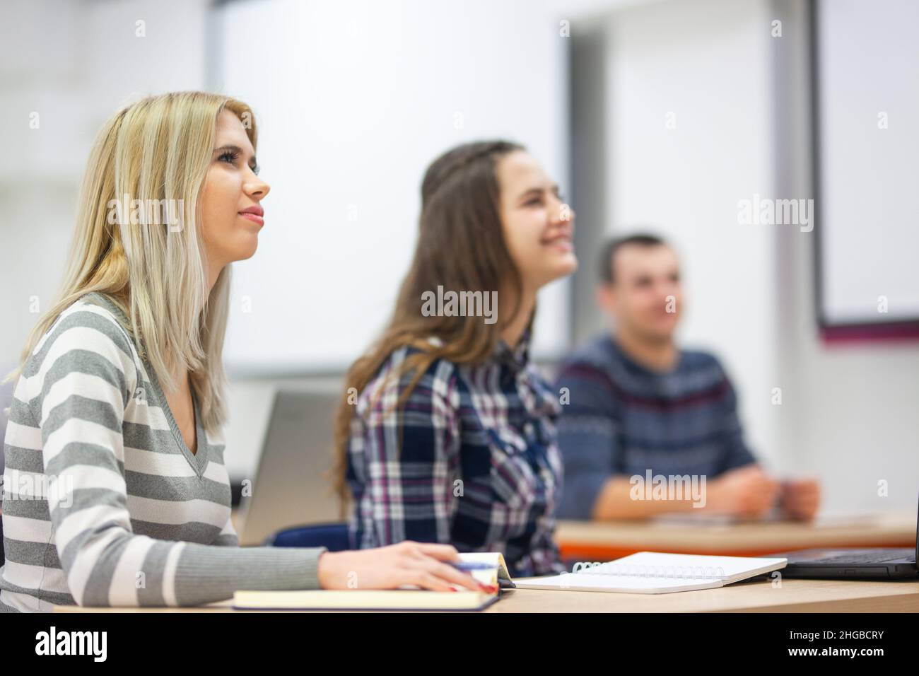 Young student in modern classroom listening to lecture Stock Photo - Alamy
