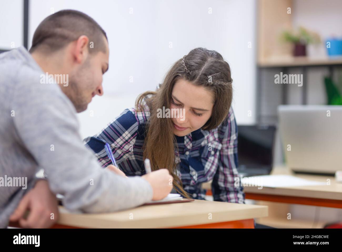 Students talking to each other during class in a modern classroom Stock ...