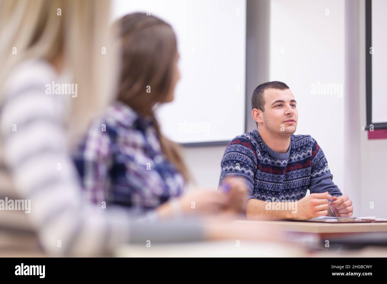Young student in modern classroom listening to lecture Stock Photo - Alamy