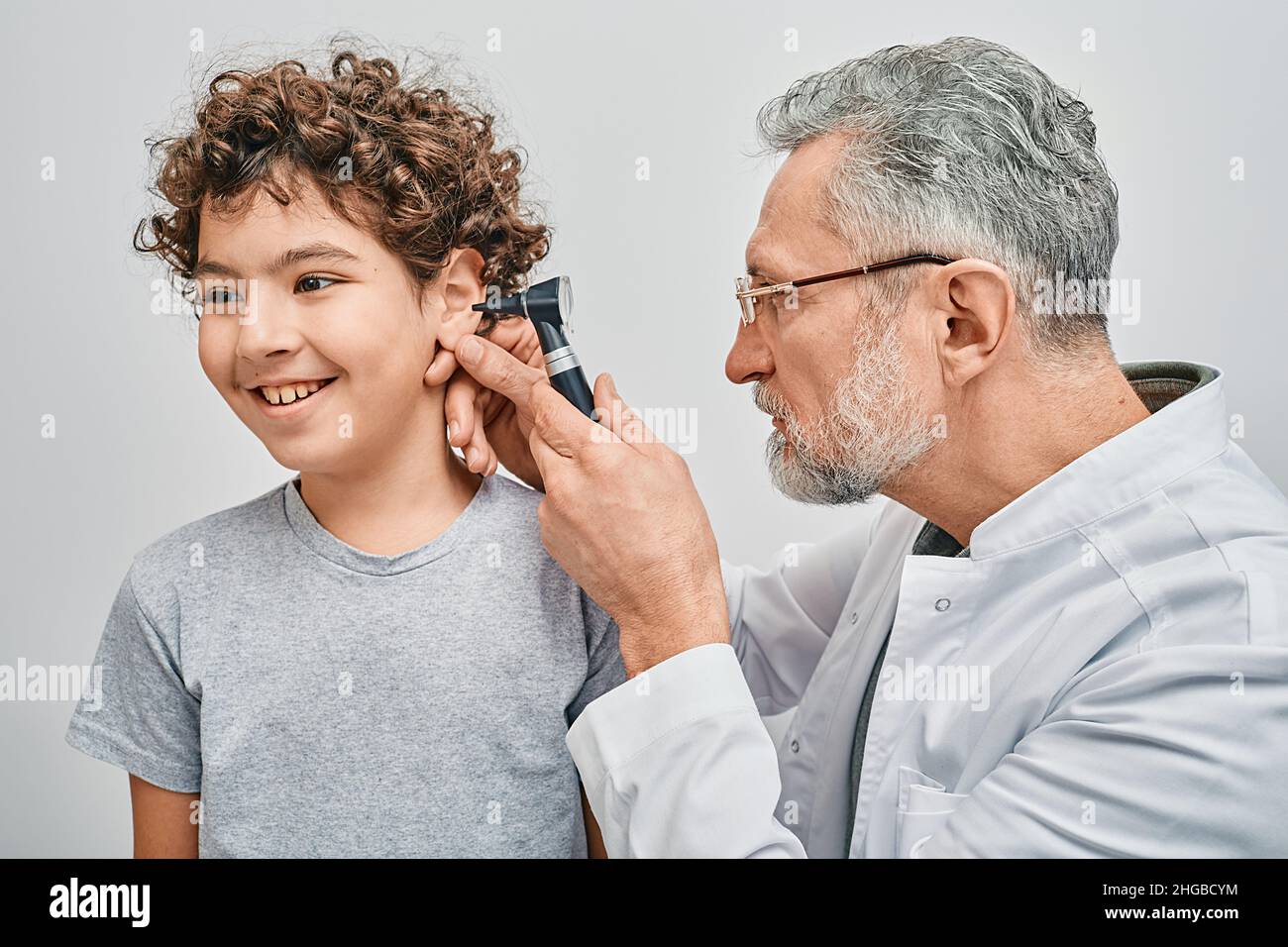 Positive curly male child while ear examining at hearing clinic. ENT ...