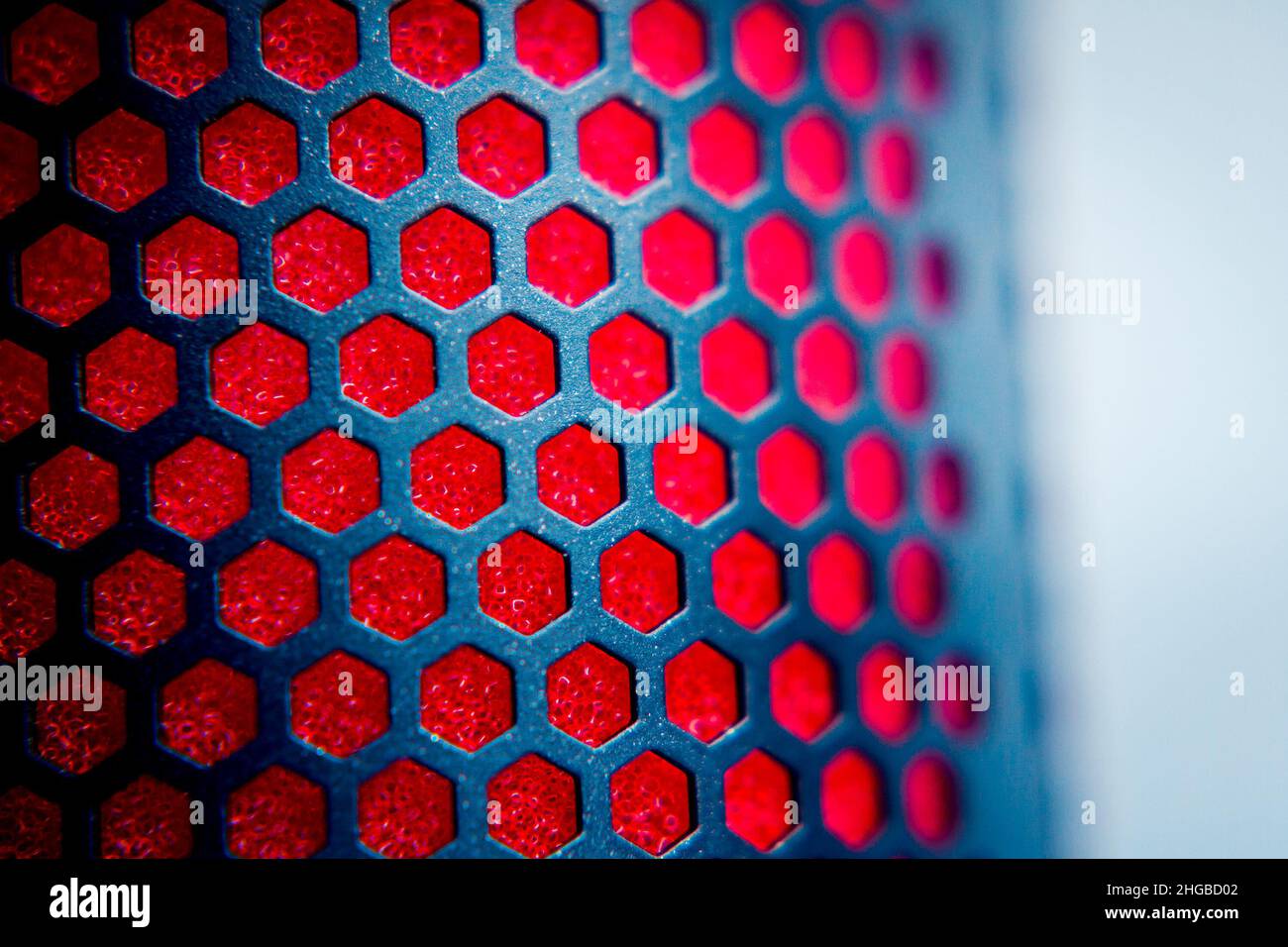 Hexagonal texture of metal casing on red microphone Stock Photo - Alamy