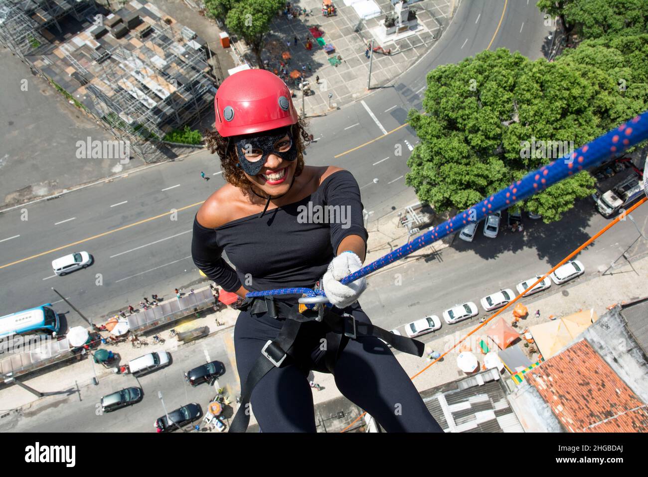 A woman wearing a hero costume with protective helmet walking down a ...