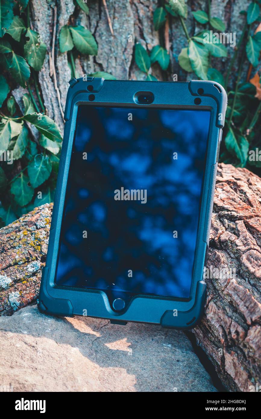 Tablet sitting out in nature Stock Photo - Alamy