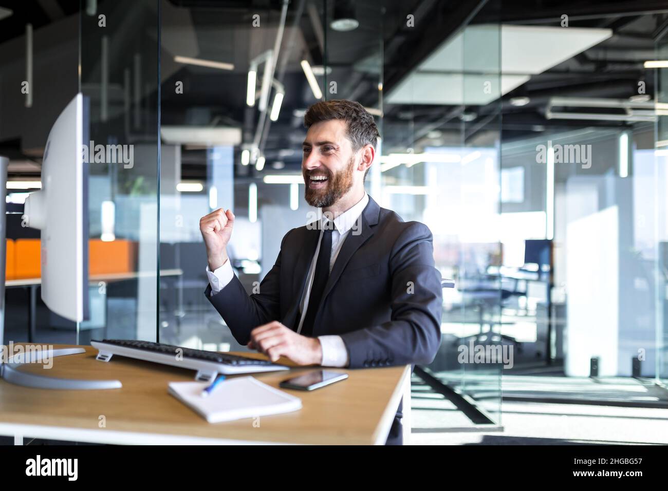 Successful seo man, boss business man, celebrates victory by working on ...