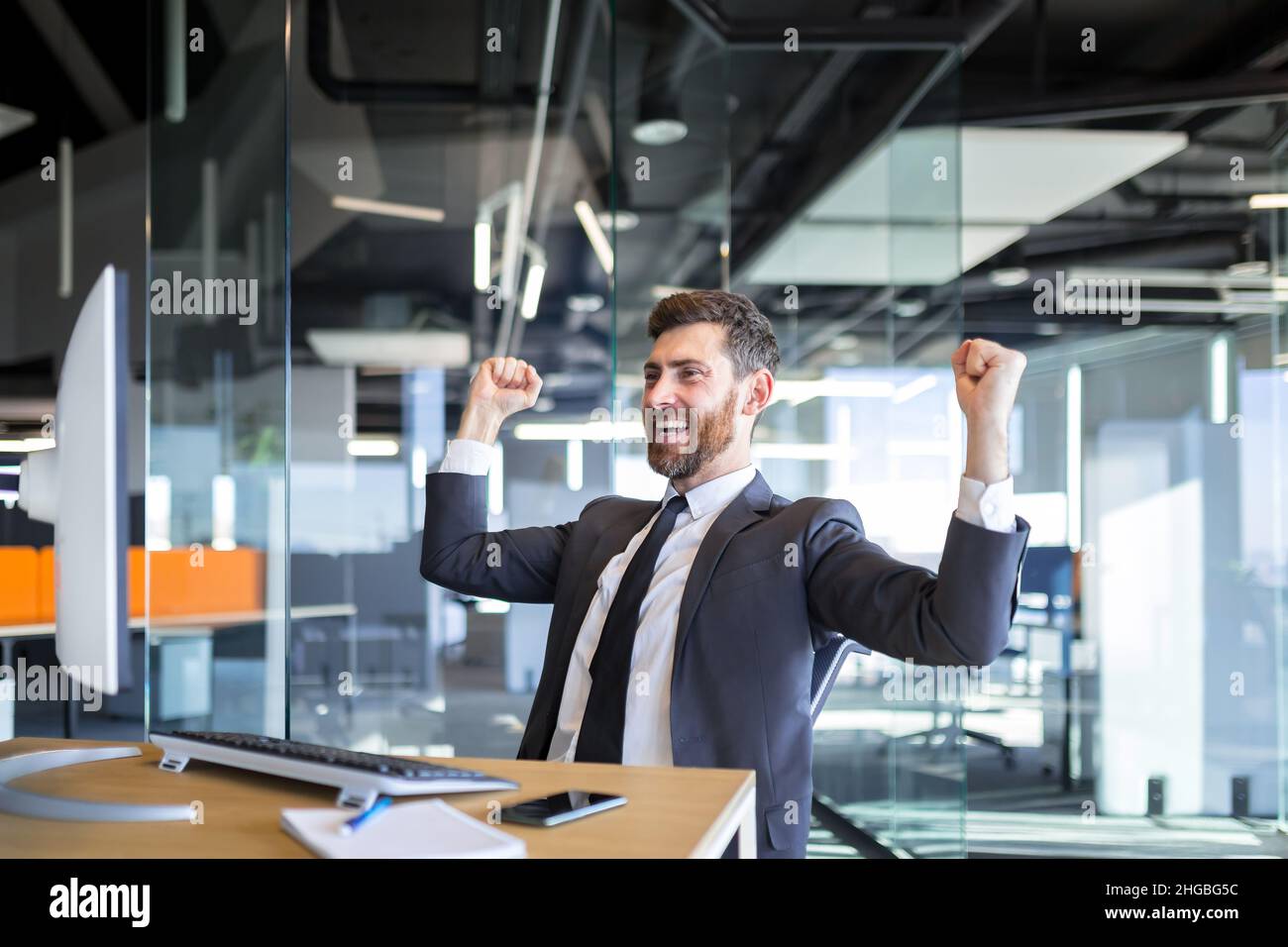 Successful seo man, boss business man, celebrates victory by working on ...