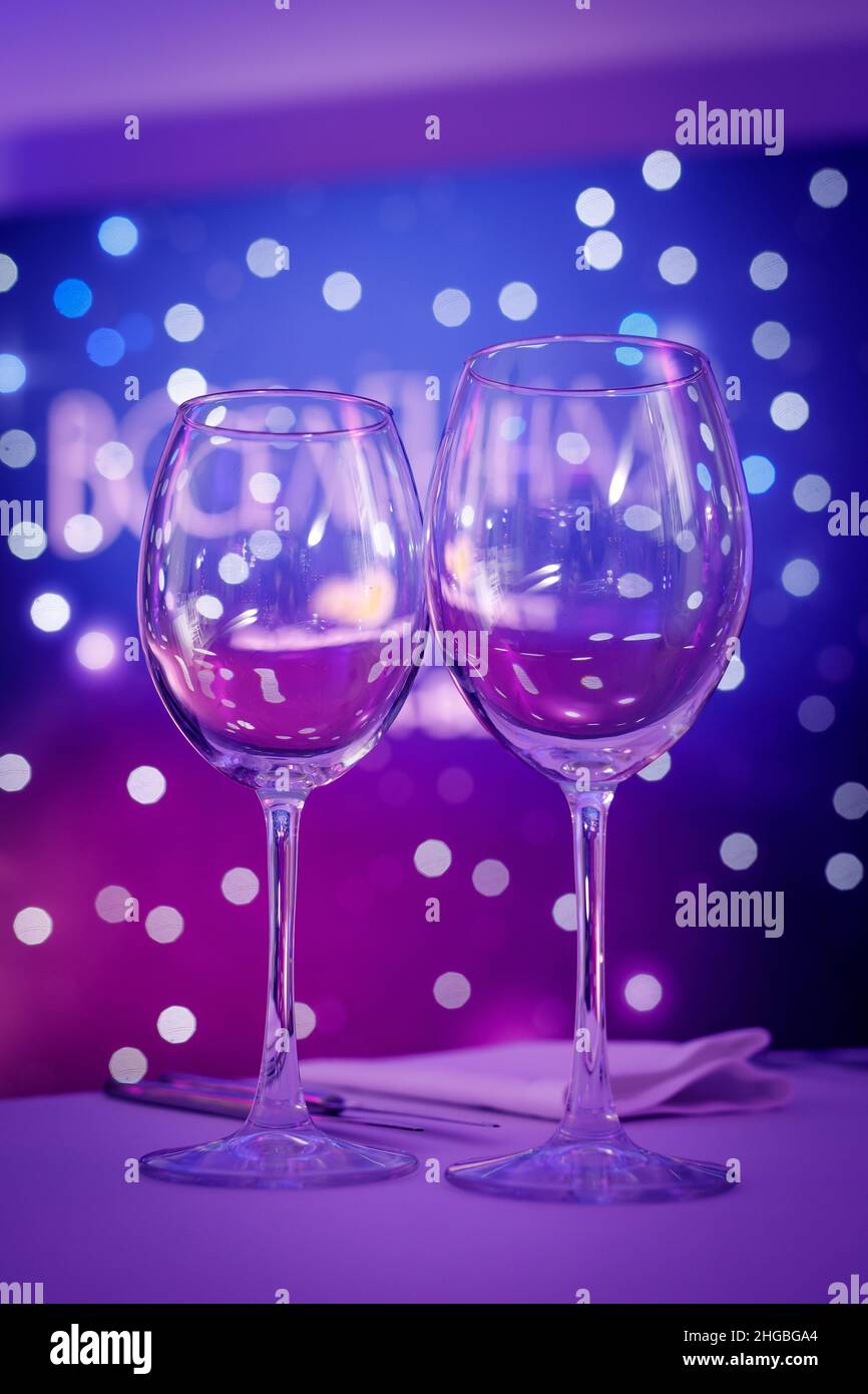 Empty wine glass with purple bokeh Stock Photo - Alamy
