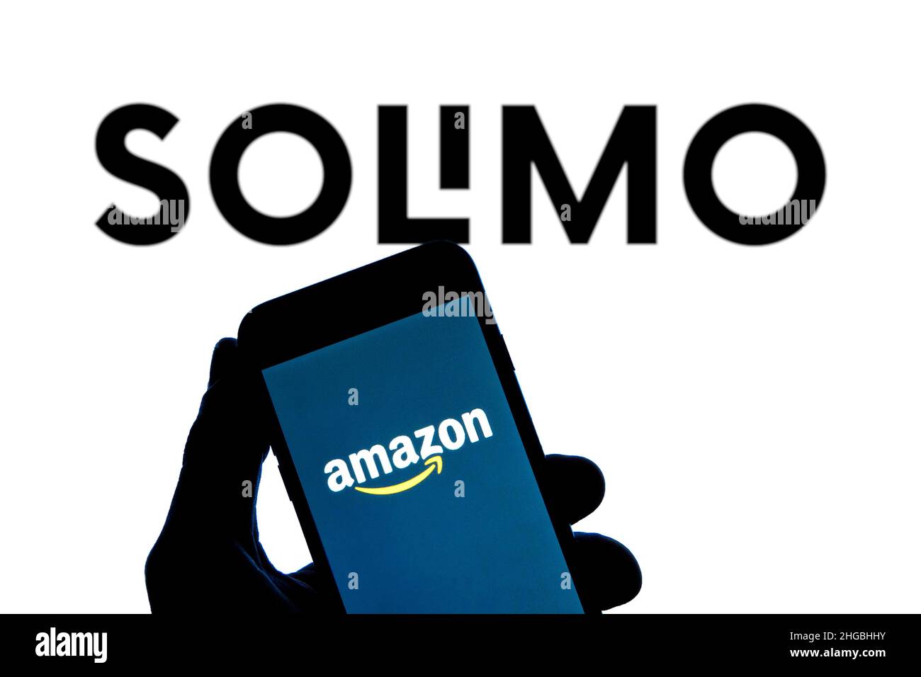 In this photo illustration an Amazon logo seen displayed on a smartphone with a Solimo logo, an ...
