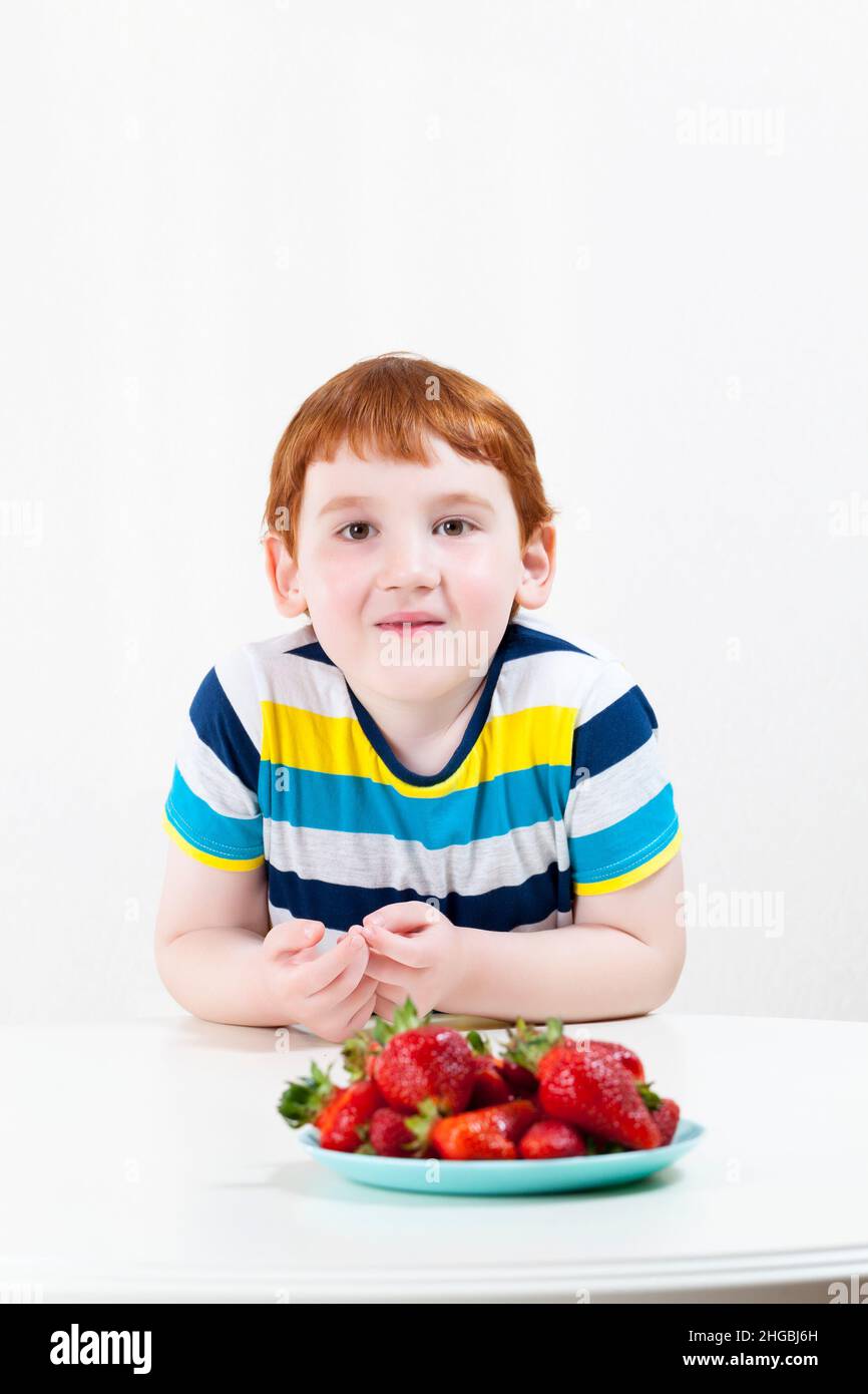 Boy eats strawberries hi-res stock photography and images - Alamy