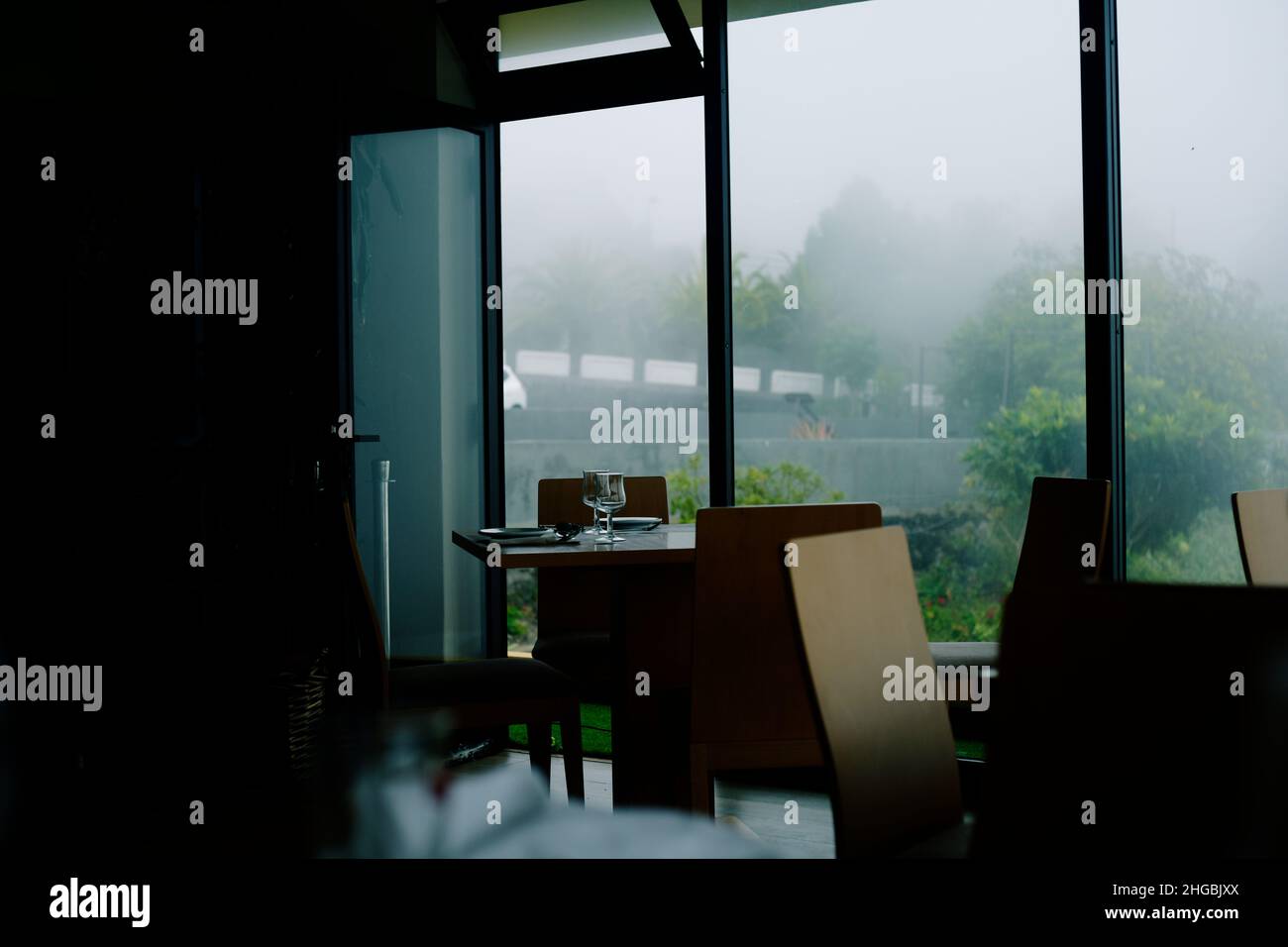 Empty restaurant in the mountains in Spain, outside the window is fog ...